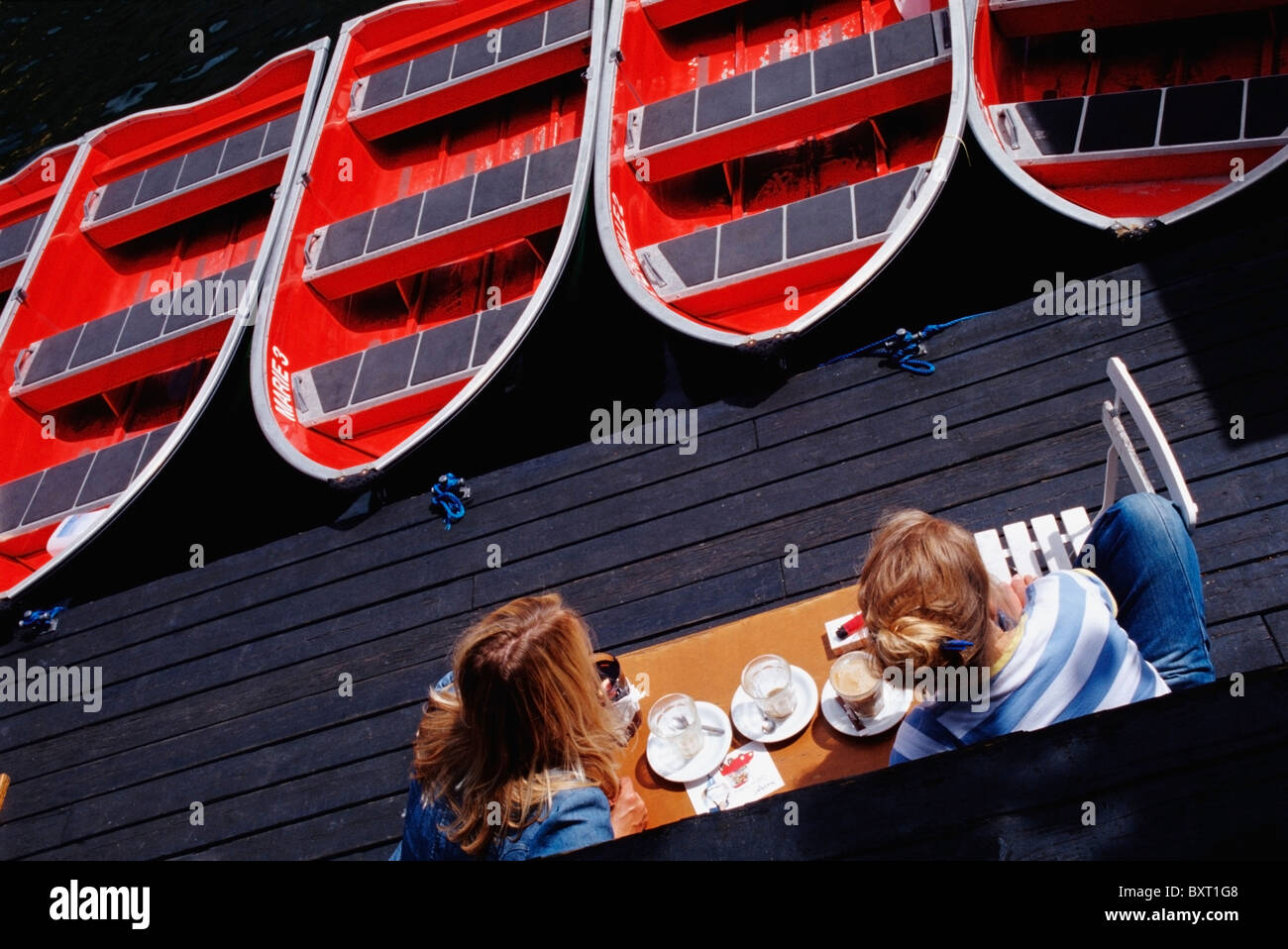 Blonde women sitting at a table hi-res stock photography and images - Alamy