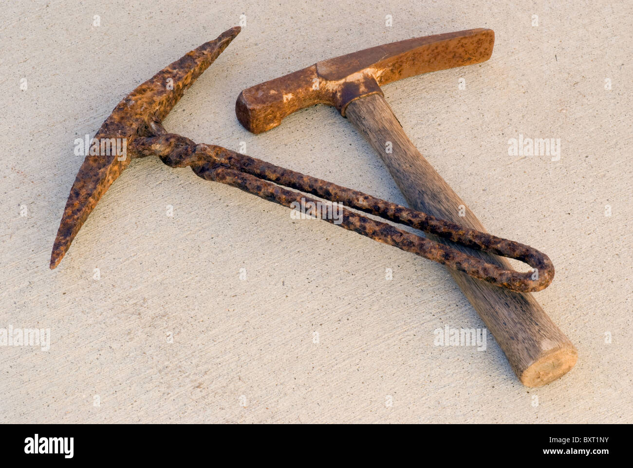 2 old mining picks - one is twisted wrought iron and the other has a ...