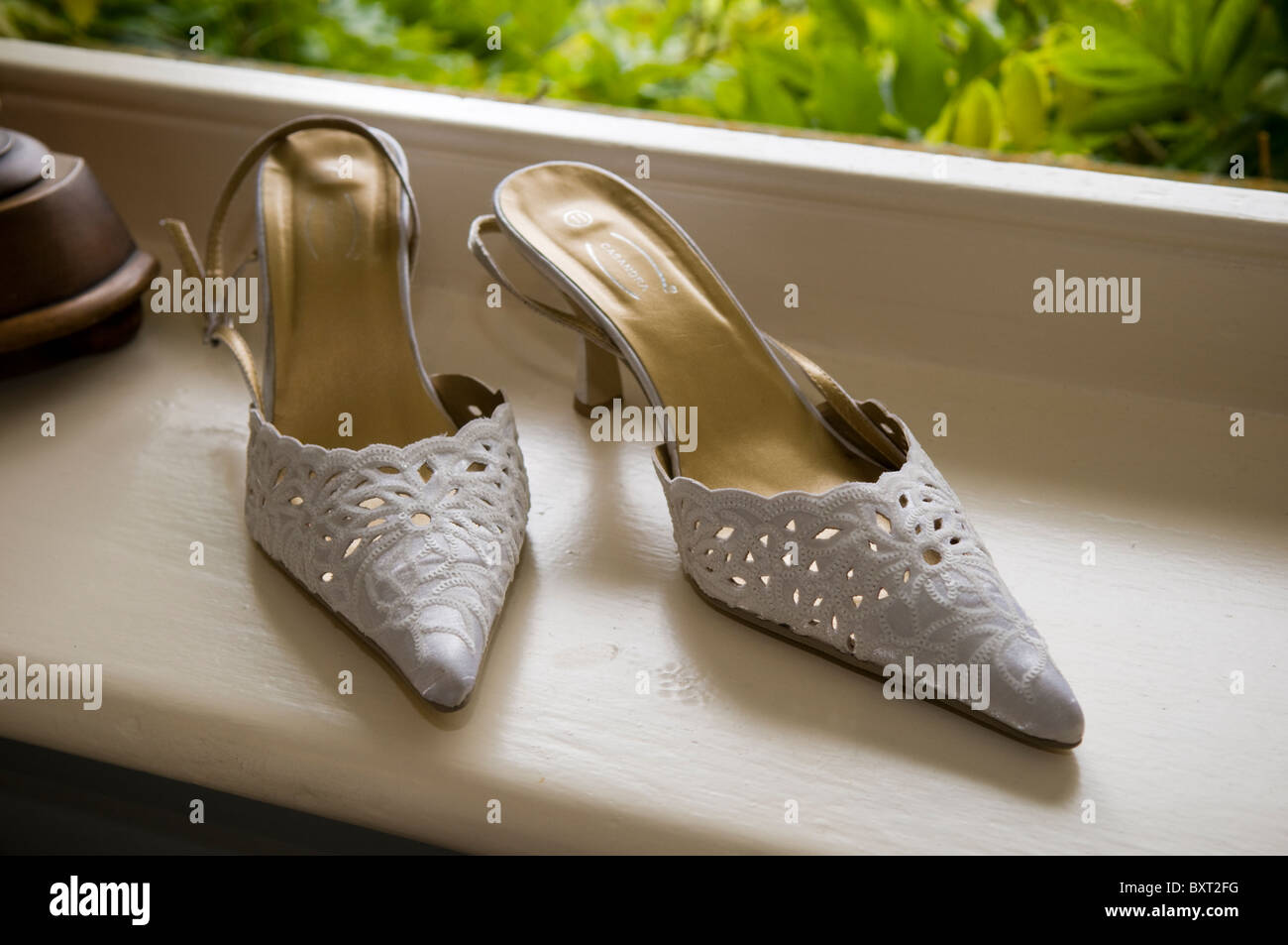 A Pair of White Bridal Shoes on a Window Sill Stock Photo - Alamy