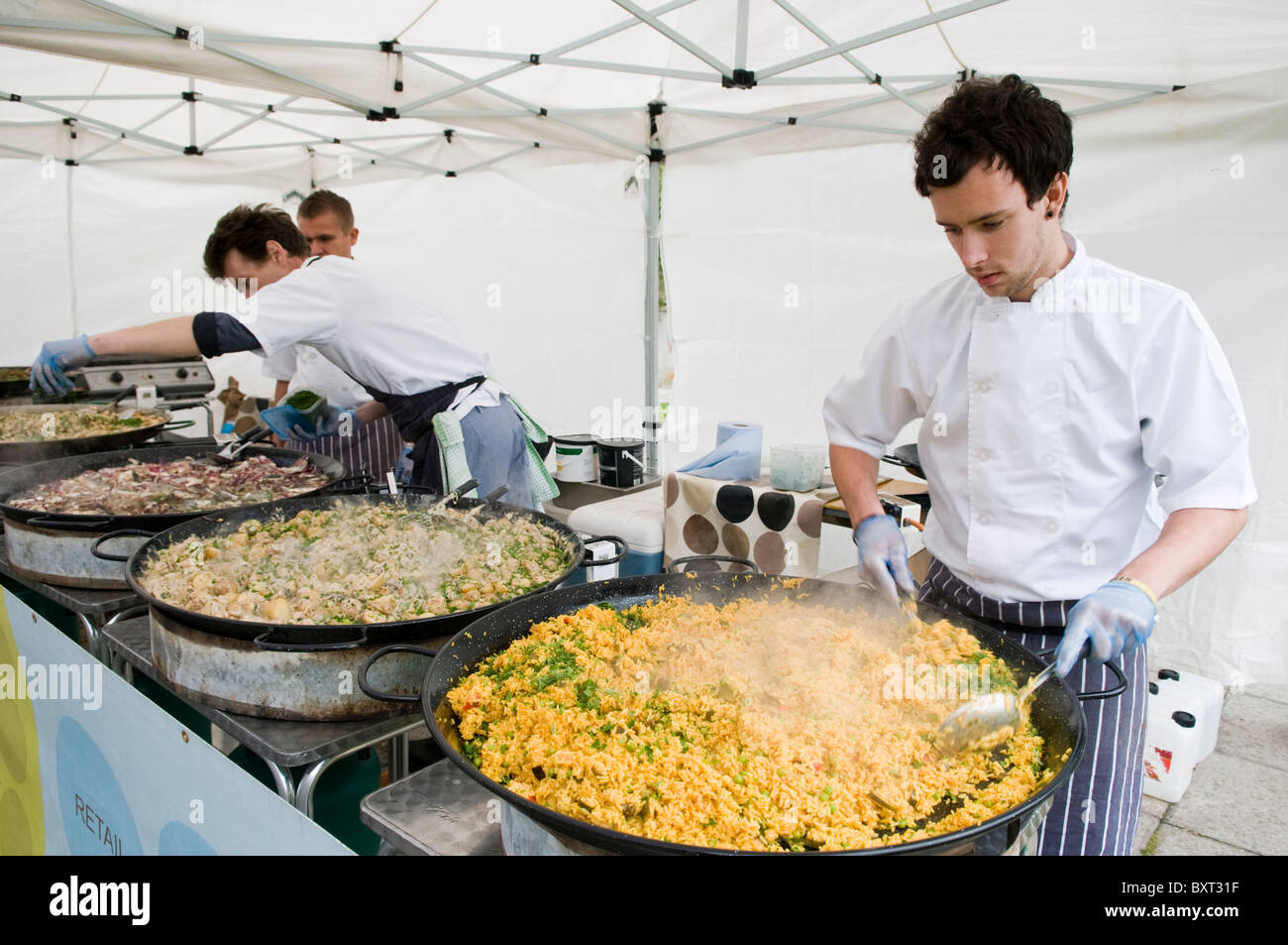 Three chef's preparing dinner in a marquee using very large ...