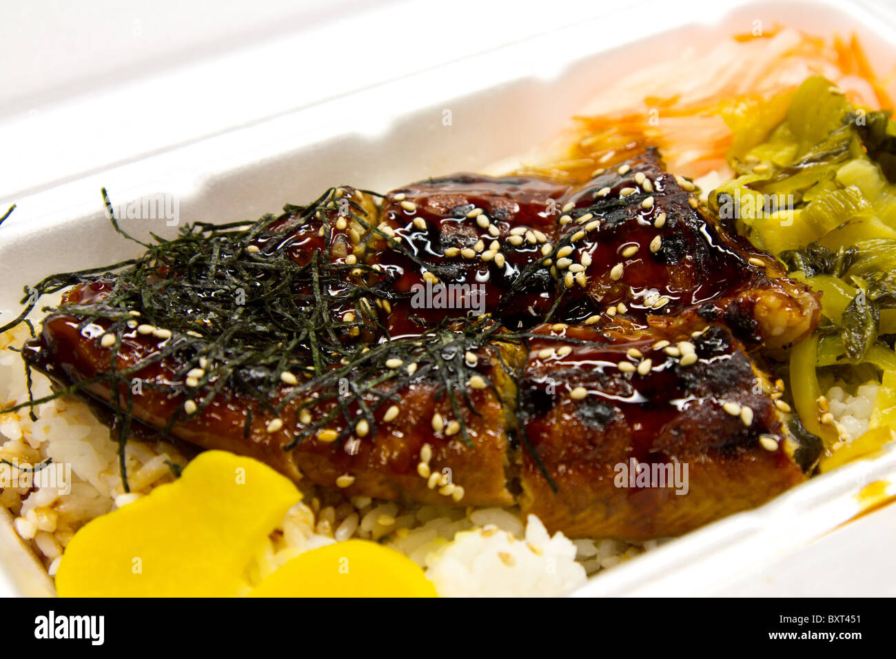 Eel on rice with vegetable in a white take out lunch box Stock Photo ...