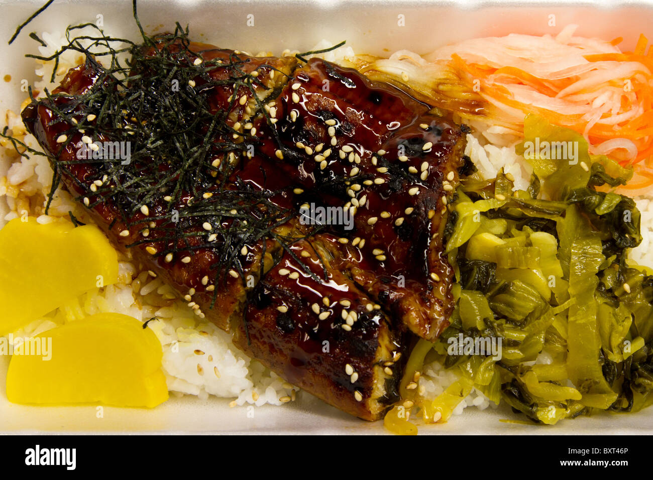 Eel on rice with vegetable in a white take out lunch box Stock Photo ...