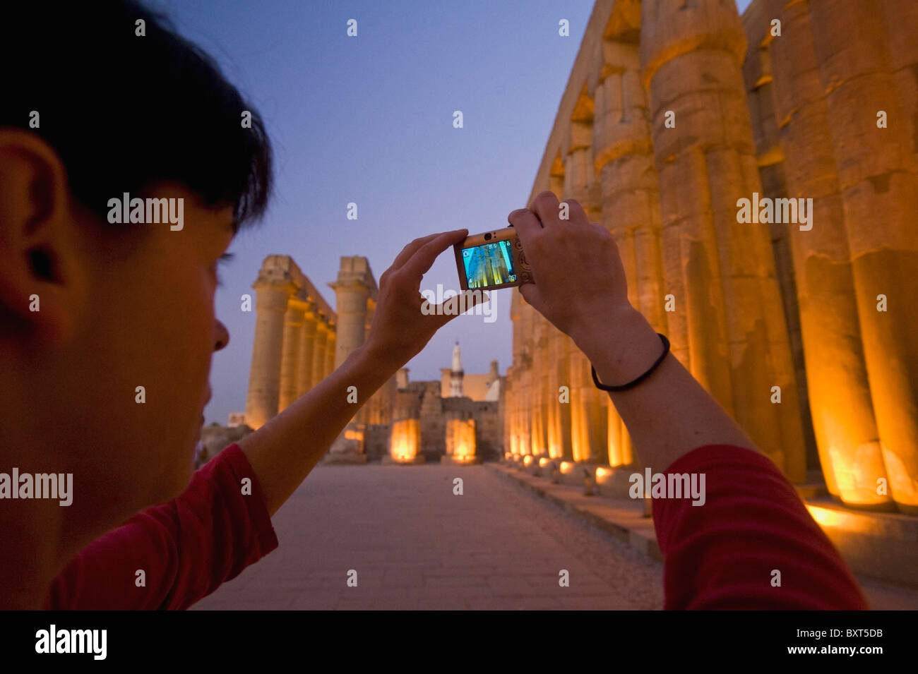 Woman Taking Photographs At Dusk Of Papyrus-Bundle Columns In Courtyard ...