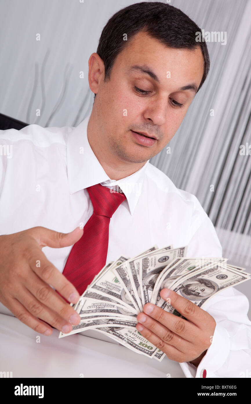 Businessman at the office enjoying his money Stock Photo - Alamy