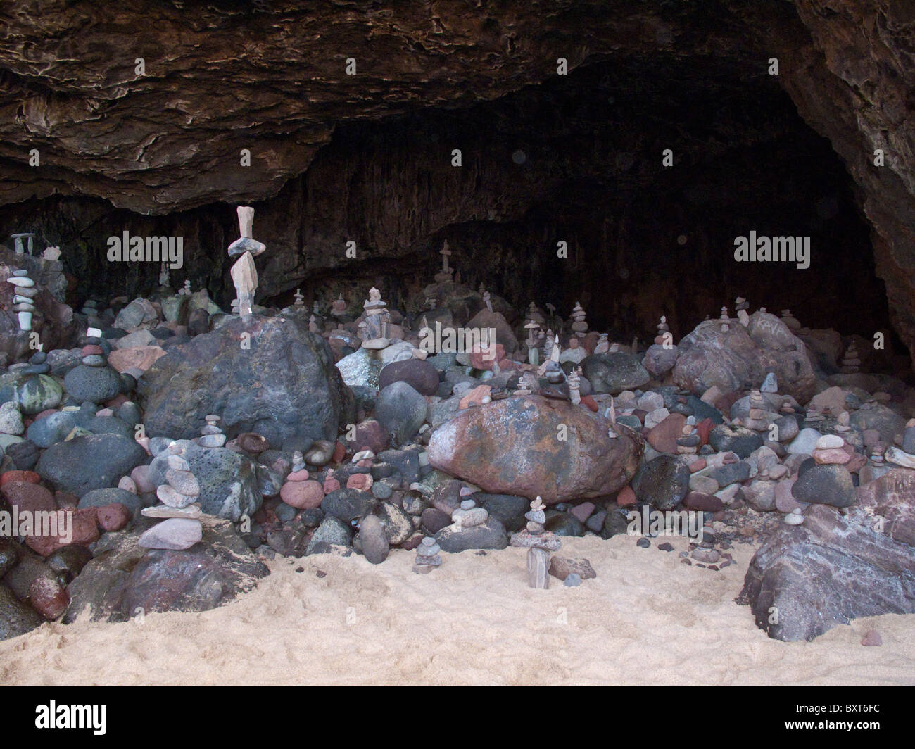 Rocks stacked up in a cave on the Na Pali coastline, Kalalau beach ...