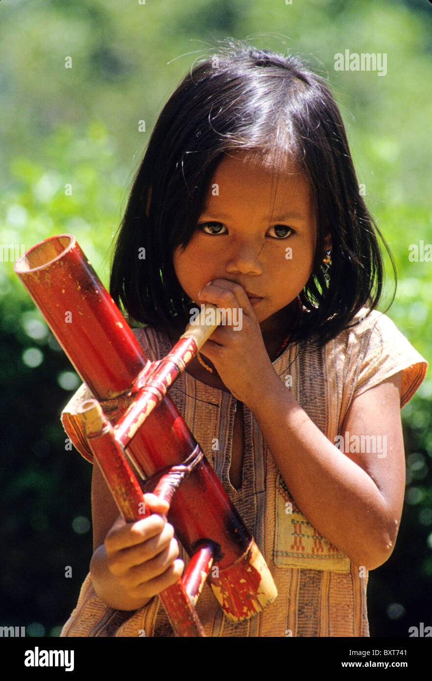 Young girl playing bamboo instrument, Tana Toraja, South Sulawesi ...