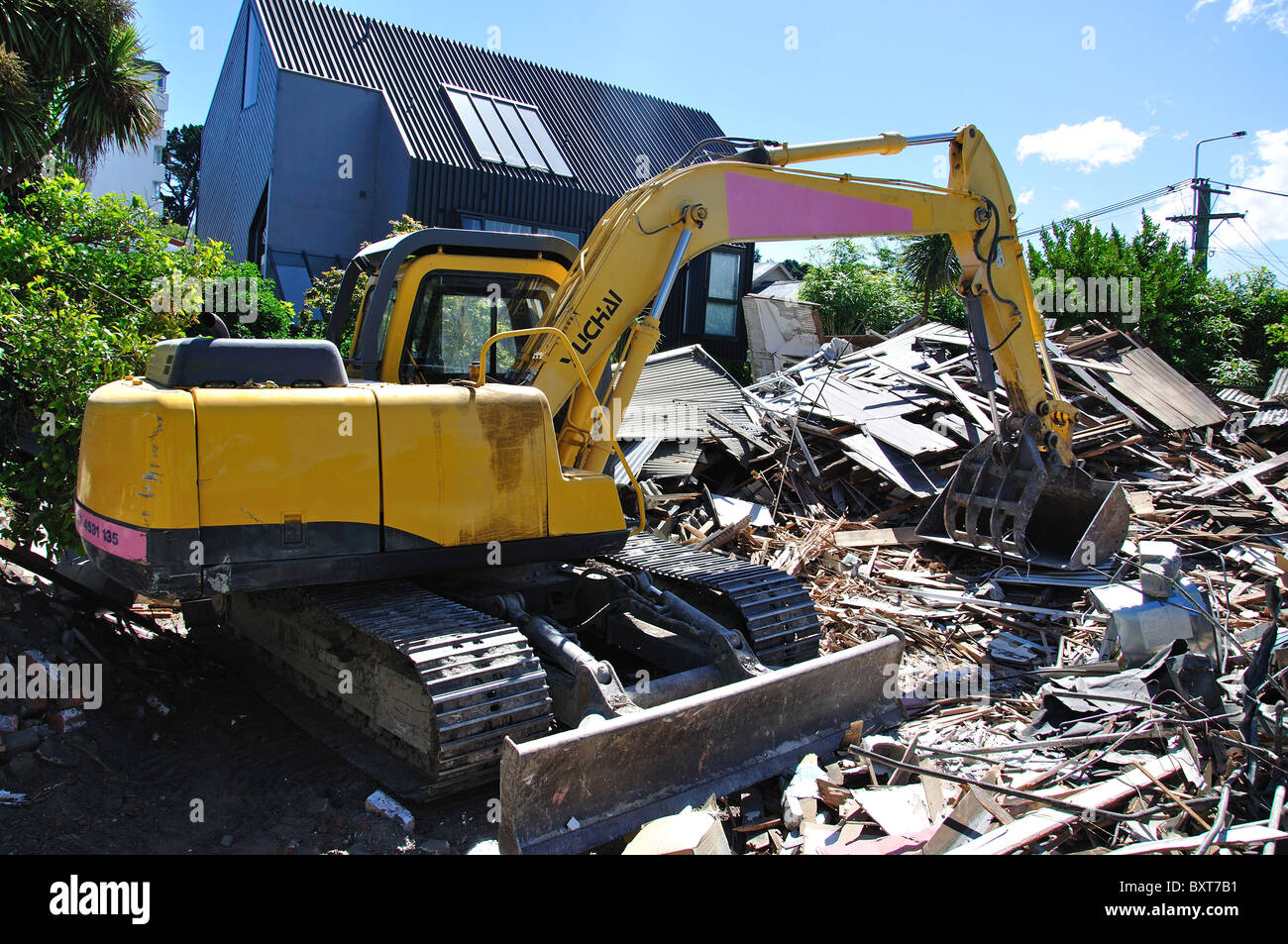Excavator demolishing house after 2011 earthquake, Christchurch ...