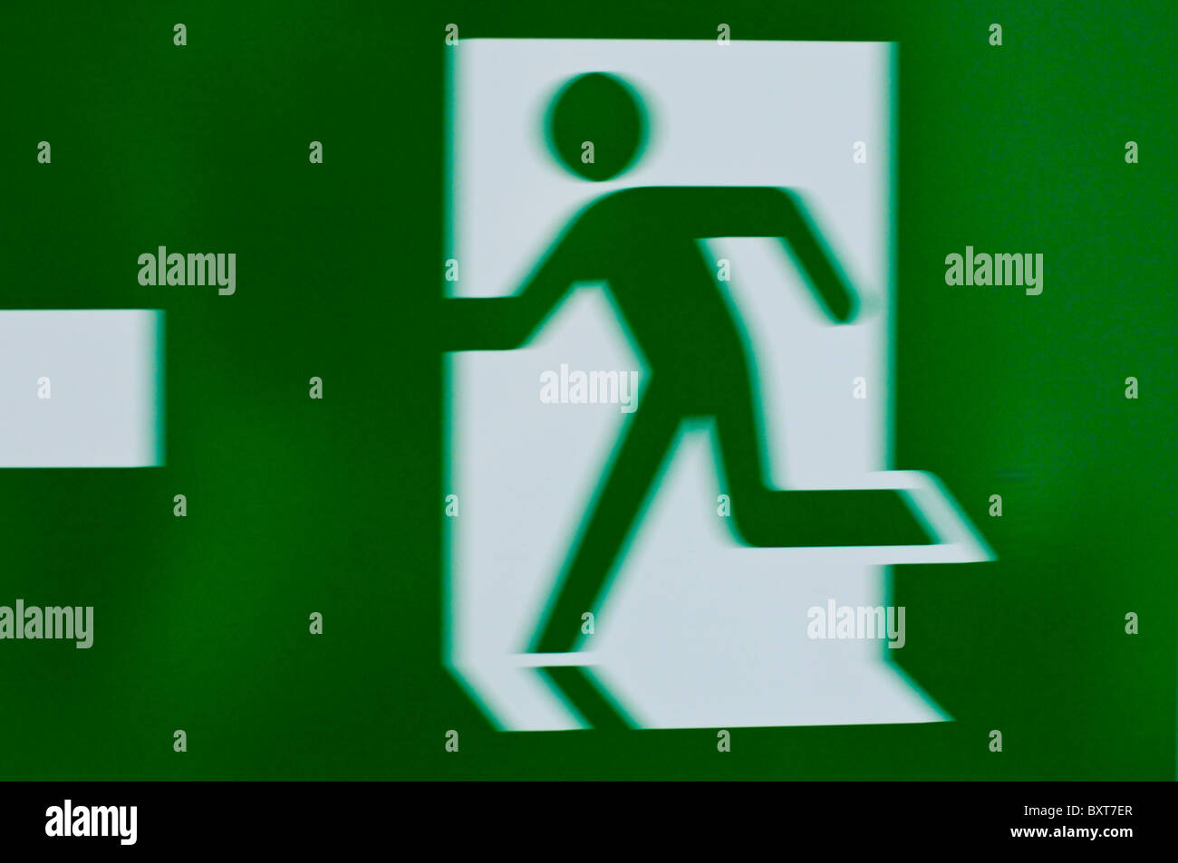 An emergency exit sign (with movement Stock Photo - Alamy