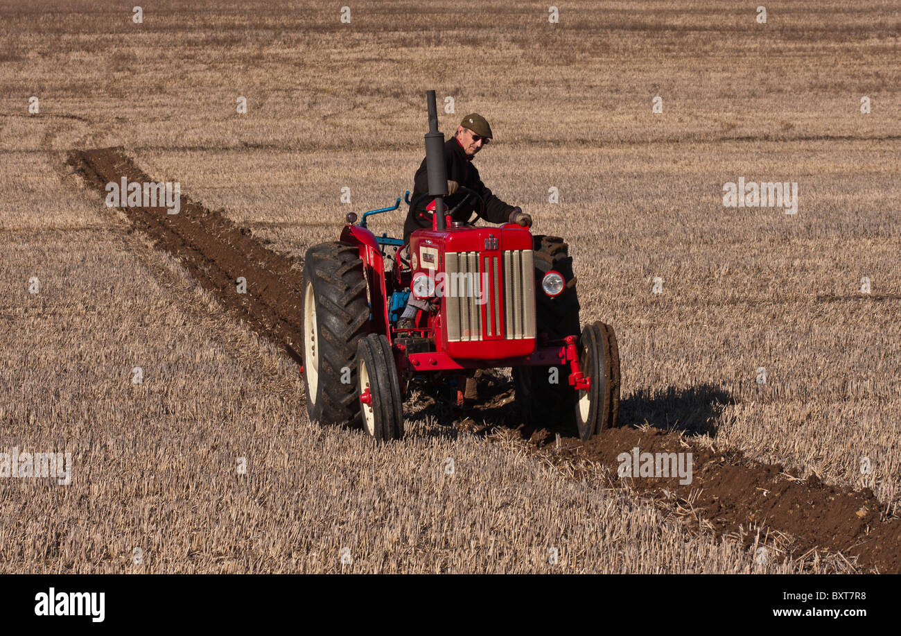 Farmer using a Tractor to plough a field in a ploughing match, UK Stock ...