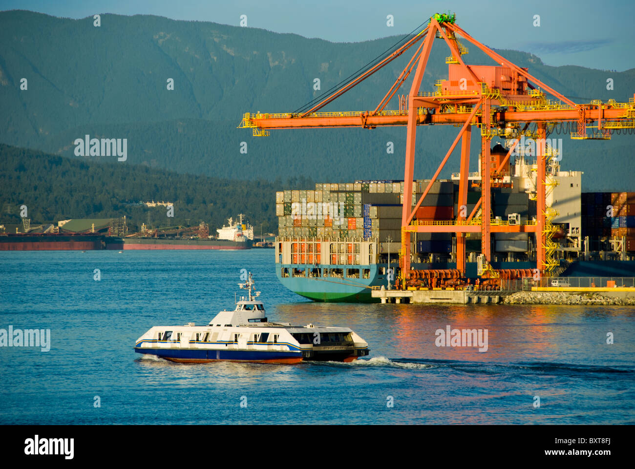 "SeaBus" passenger only ferry passing loading cranes in Port of ...