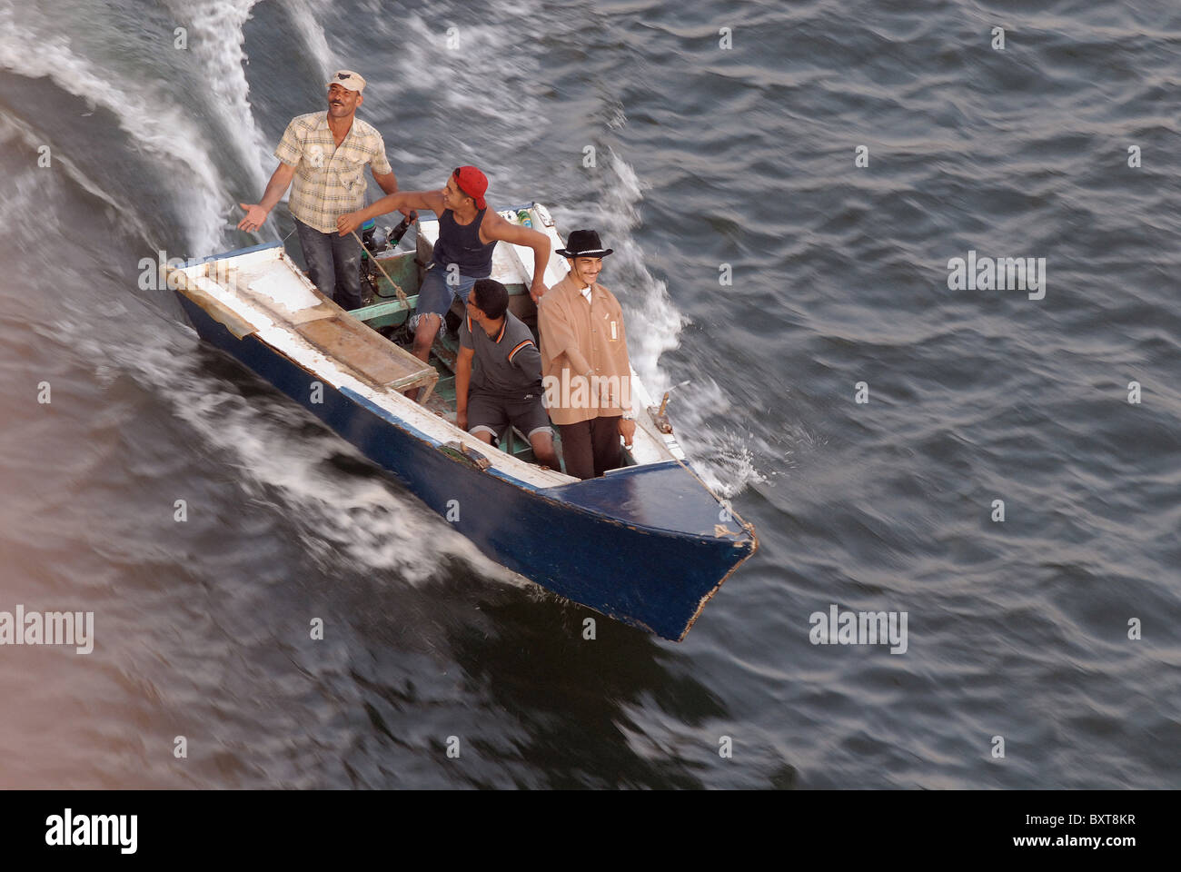 Men in small boat along side of cruse ship near Alexandra Egypt Stock ...