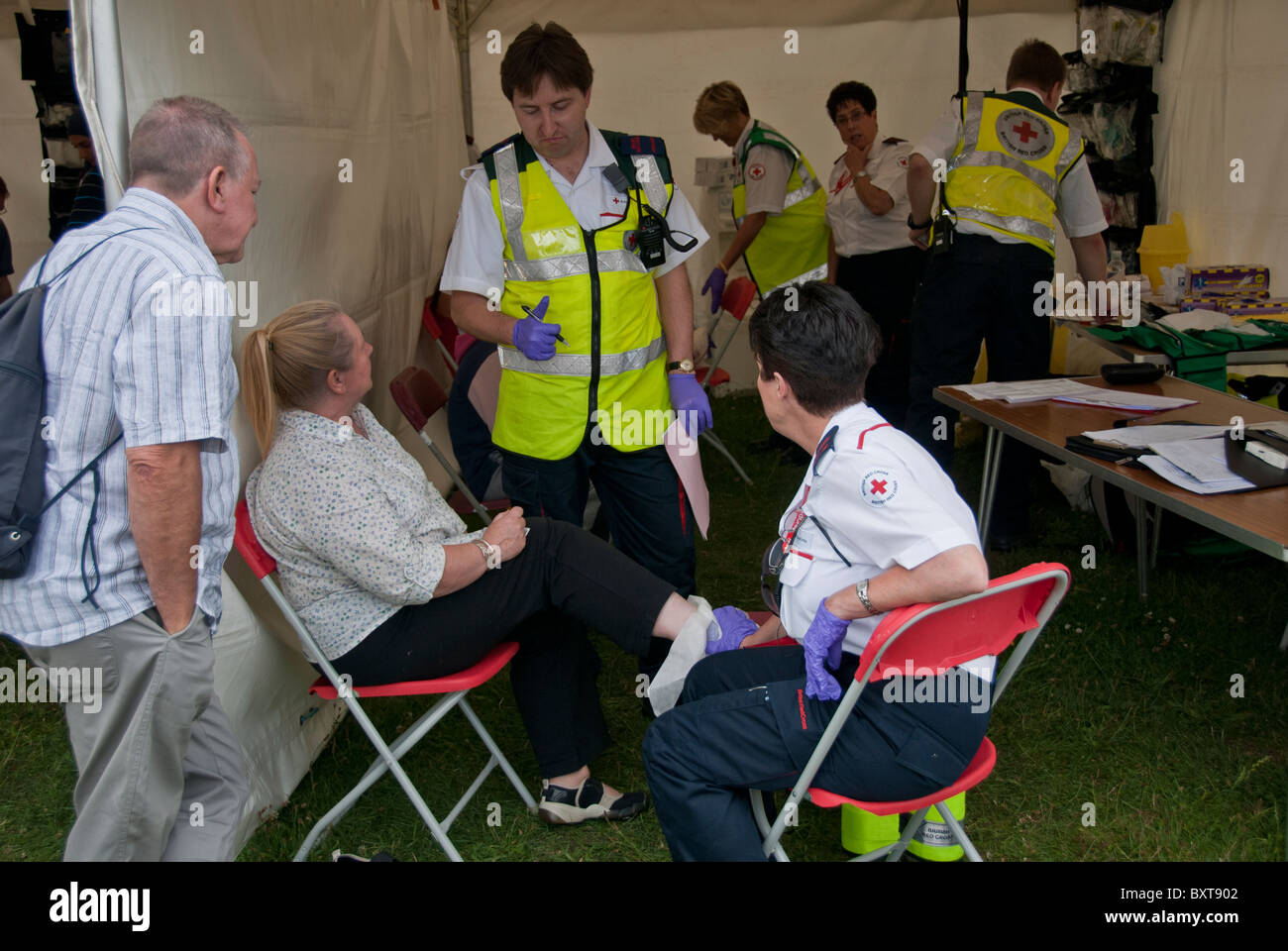 AMBULANCE STAFF COMFORTING THE UNWELL PERSON IN THE TENT Stock Photo ...