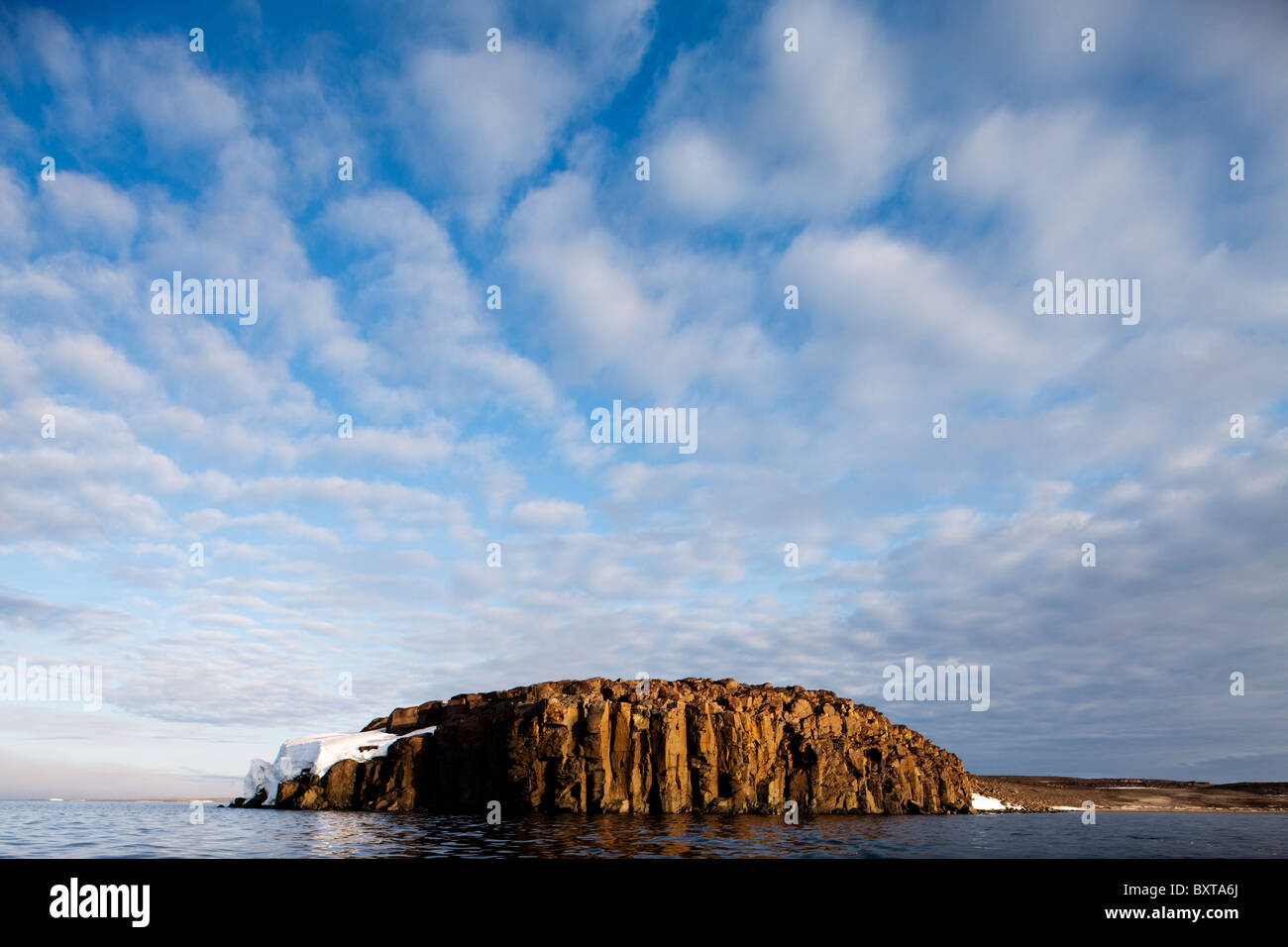 Norway, Svalbard, Nordaustlandet, Morning sun lights cliffs along ...