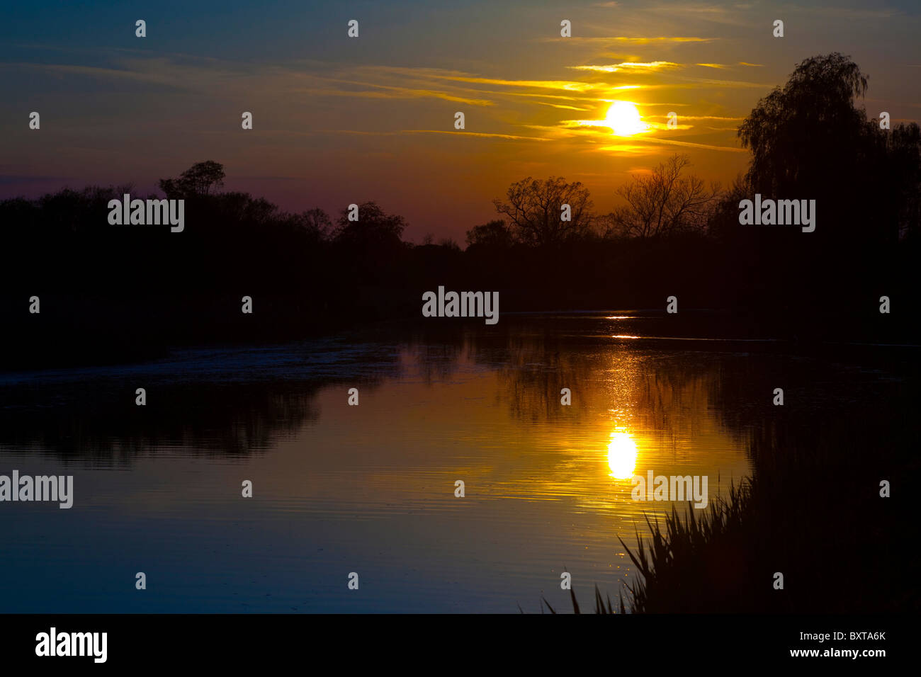 sunset over a lake Stock Photo - Alamy