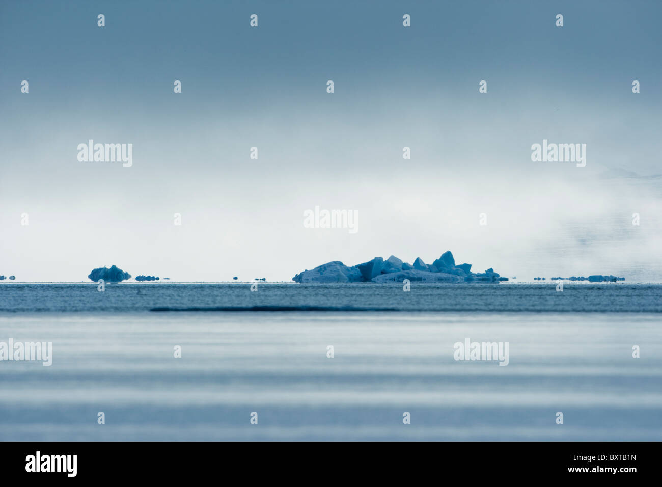 Norway, Svalbard, Spitsbergen Island, Sea ice and fog near off ...