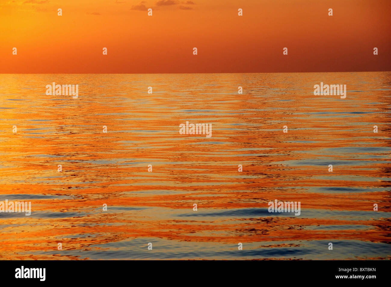 Calm Sea Surface With Orange Sunset, Low Angle View Stock Photo - Alamy