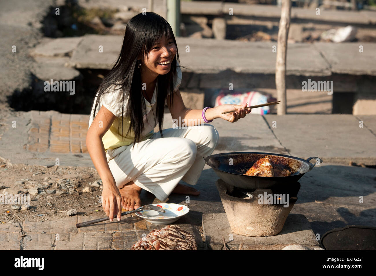 woman cooking on the pavement, Mekong Delta, Chau Doc, Vietnam Stock ...