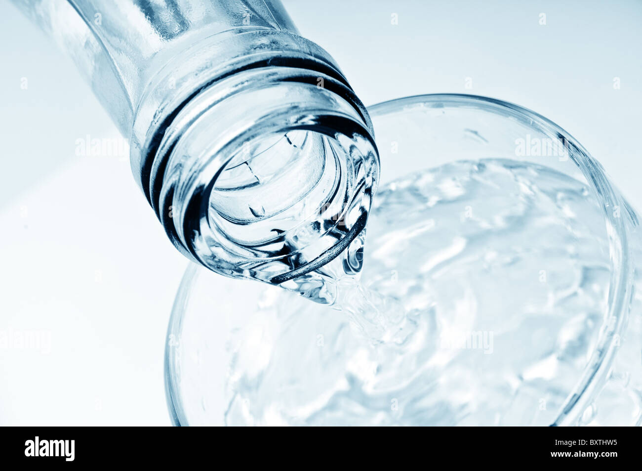 bottle pouring water into glass Stock Photo - Alamy