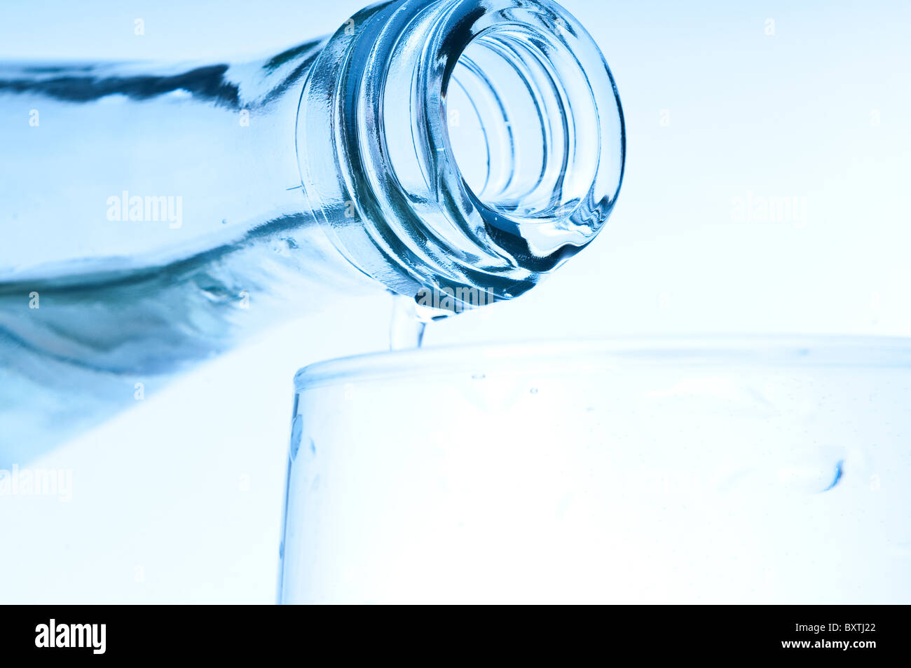 bottle pouring water into glass Stock Photo - Alamy