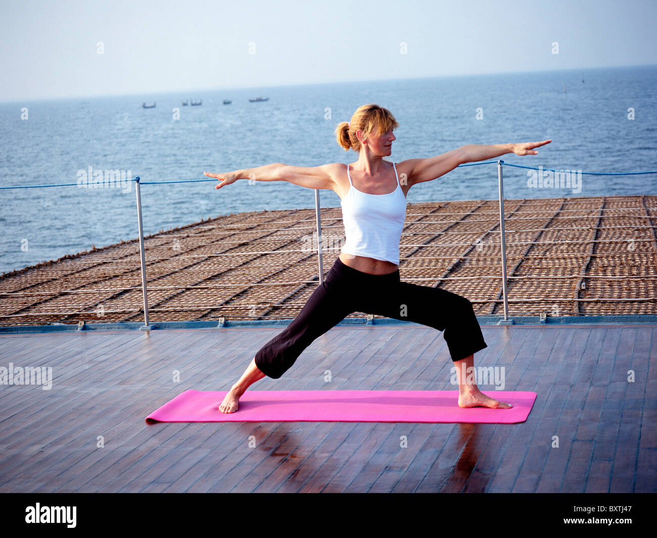 Western Woman Doing Yoga On A Cruise Boat Stock Photo - Alamy