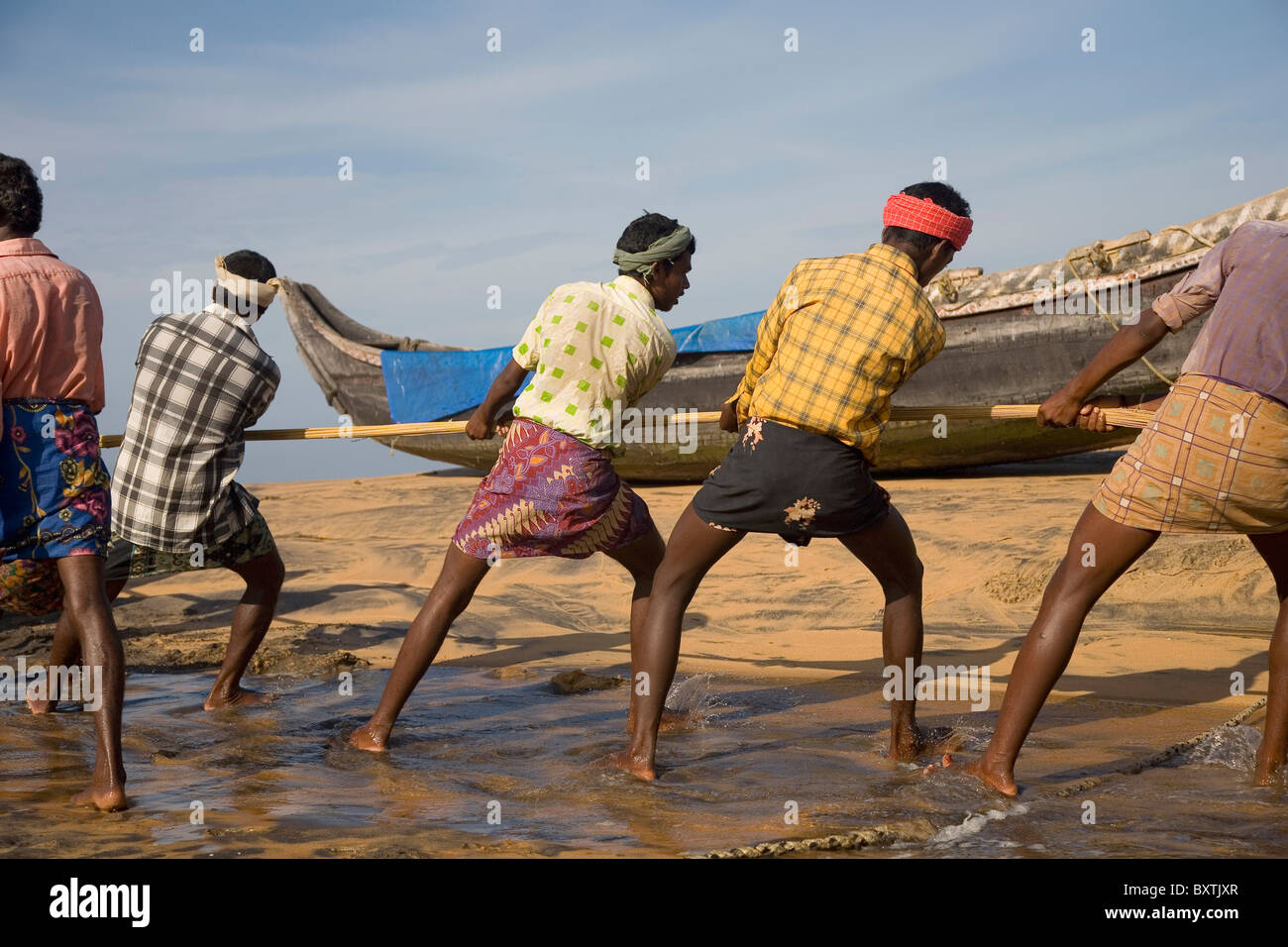 Fishermen pull nets on shore beach hi-res stock photography and images ...