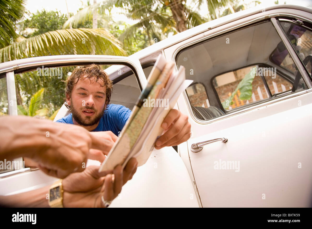 Local Man Helping Backpacker With Directions Stock Photo - Alamy