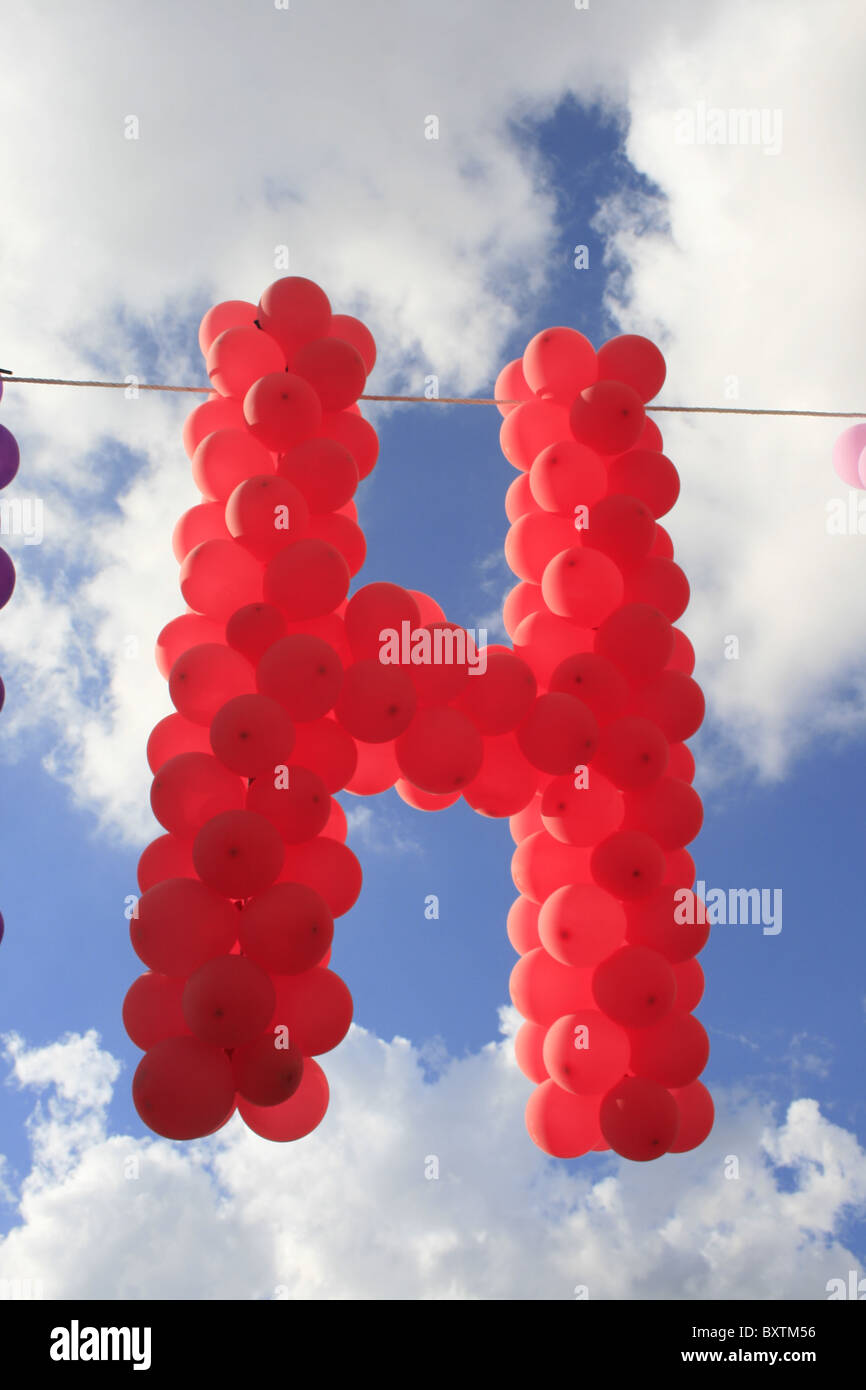 letter h formed with red balloons and blue sky Stock Photo - Alamy