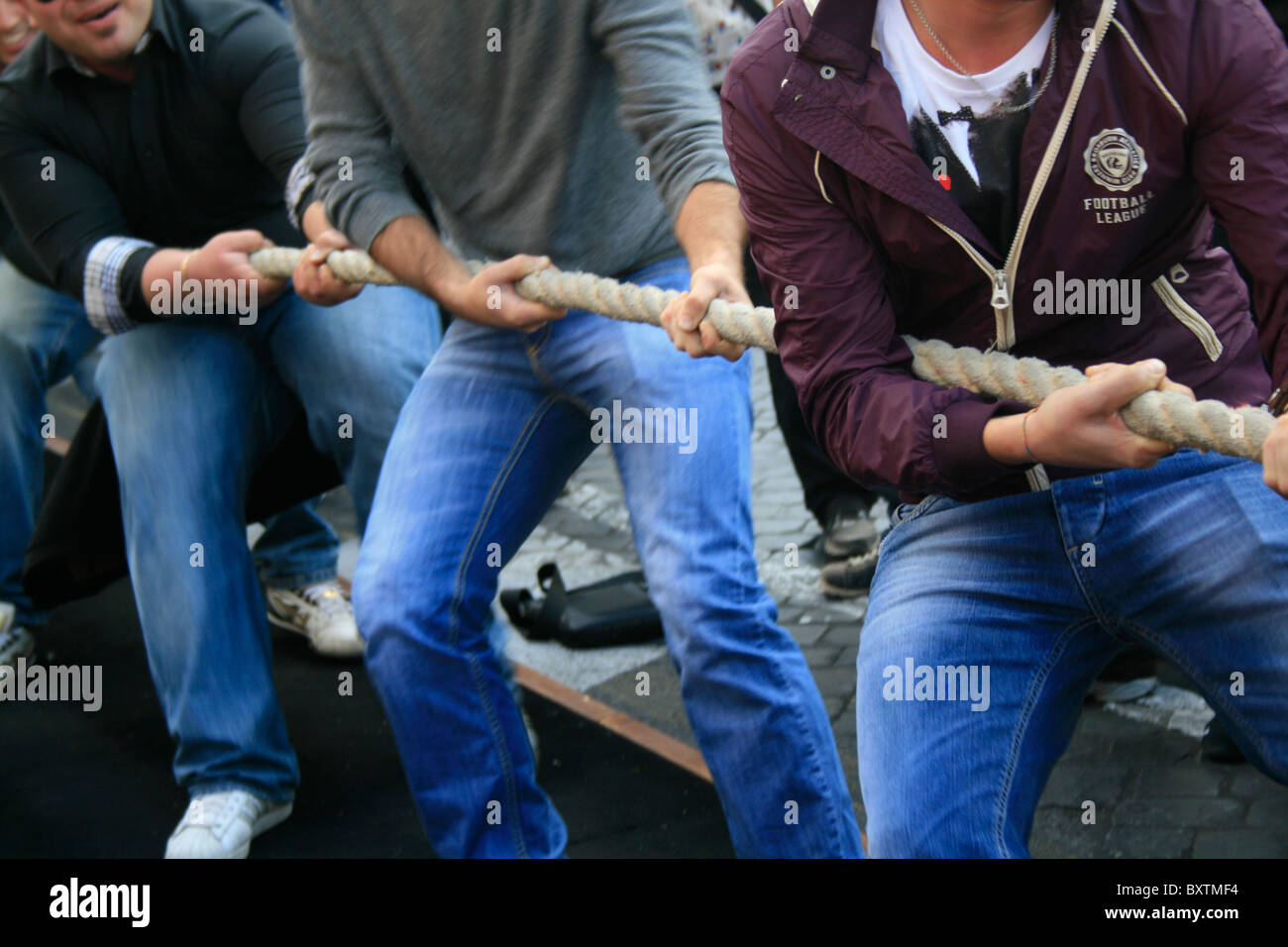 detail of men pulling rope in tug of war competition Stock Photo - Alamy