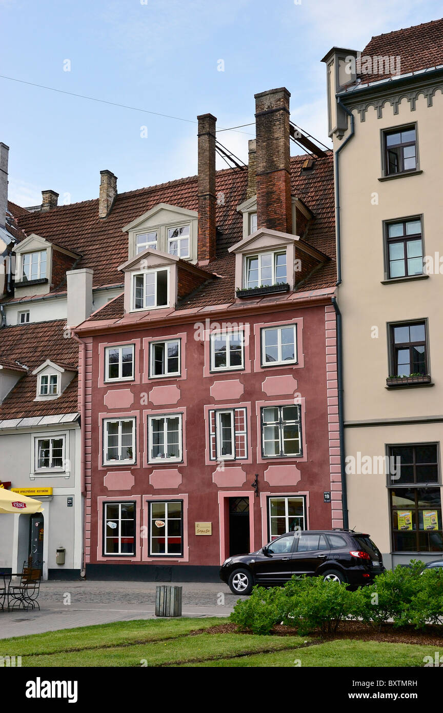 Restored medieval buildings with roof attics and very tall chimneys in ...