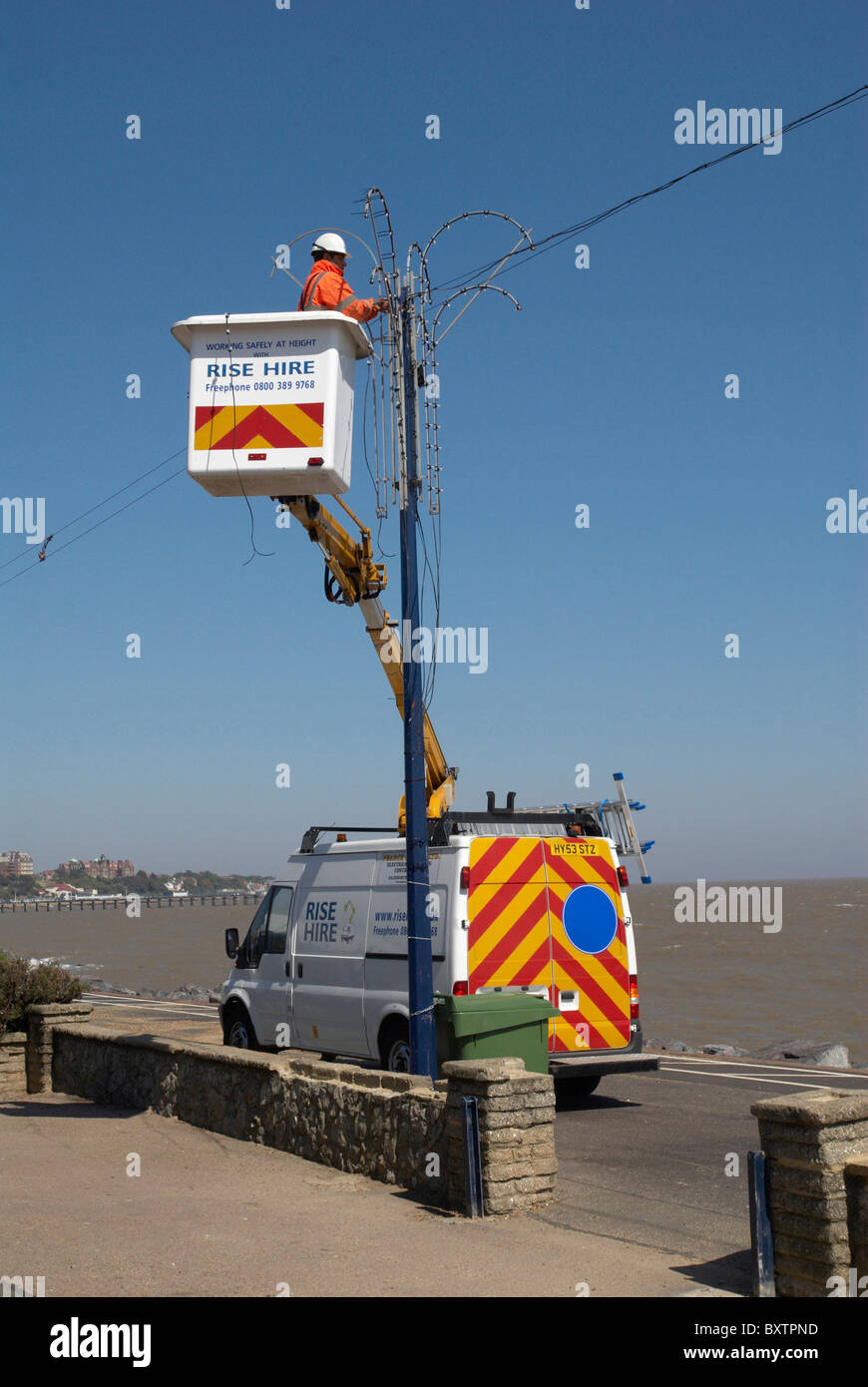 Man on cherry picker checking seaside lights Felixstowe Suffolk UK ...