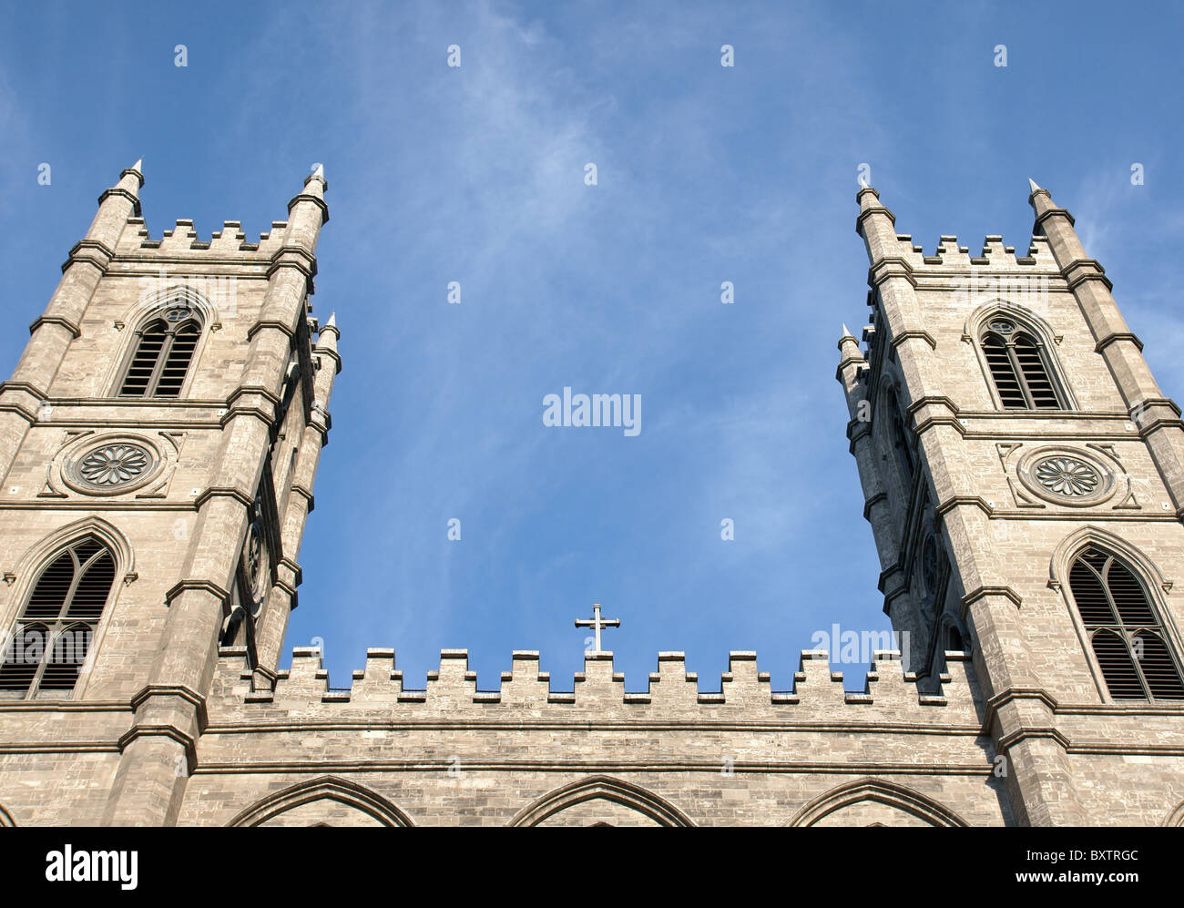 Looking up at old stone Christian church symmetrical bell towers ...