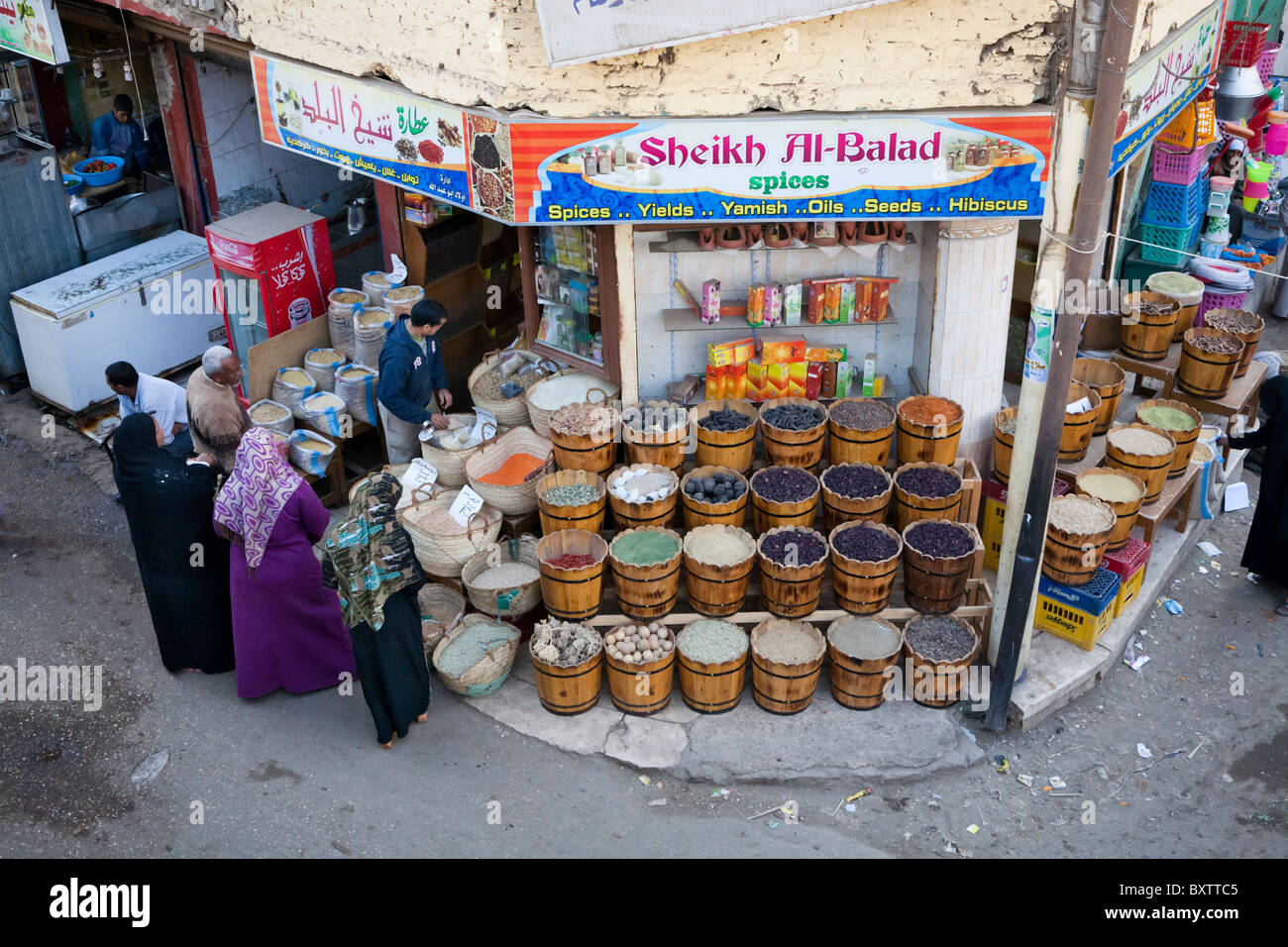 Spice shop front with display tubs and passing customers at a local ...