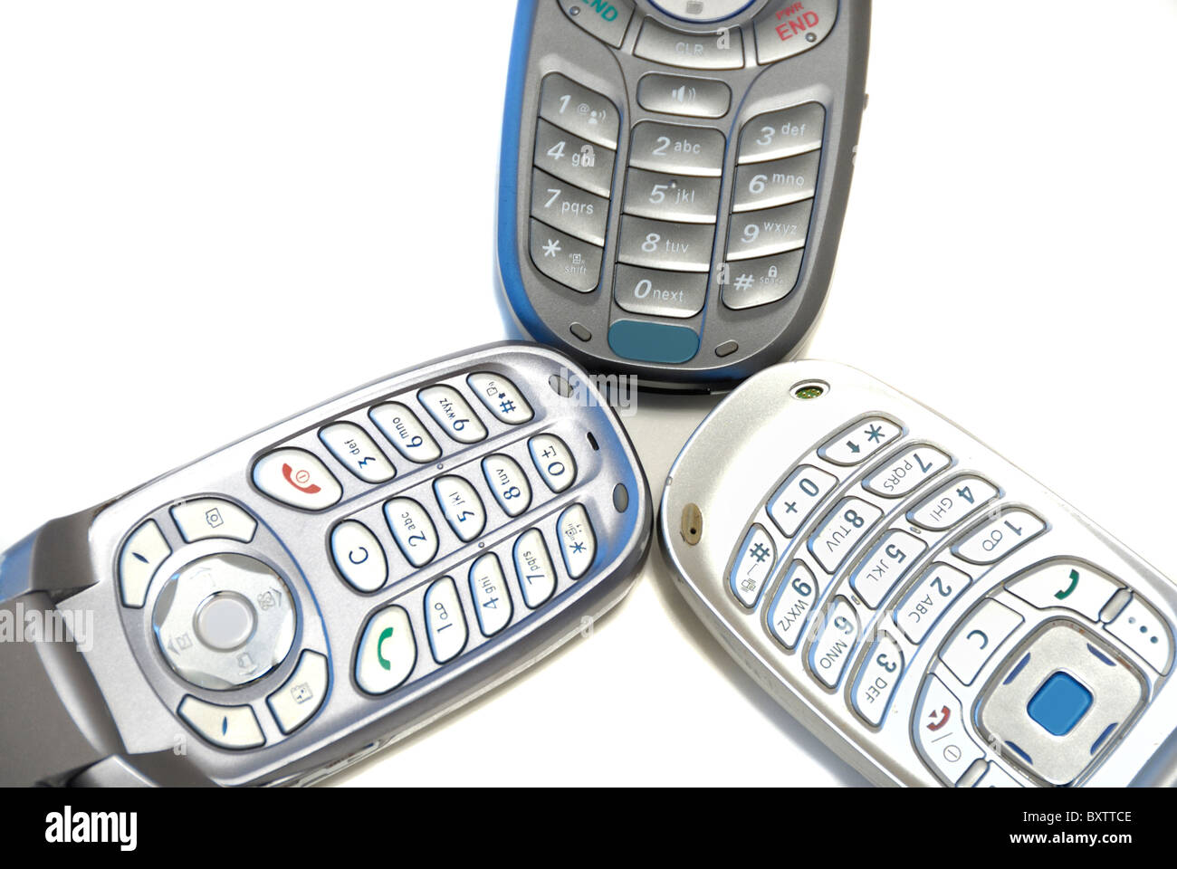 Three wireless cell phones on white background Stock Photo - Alamy