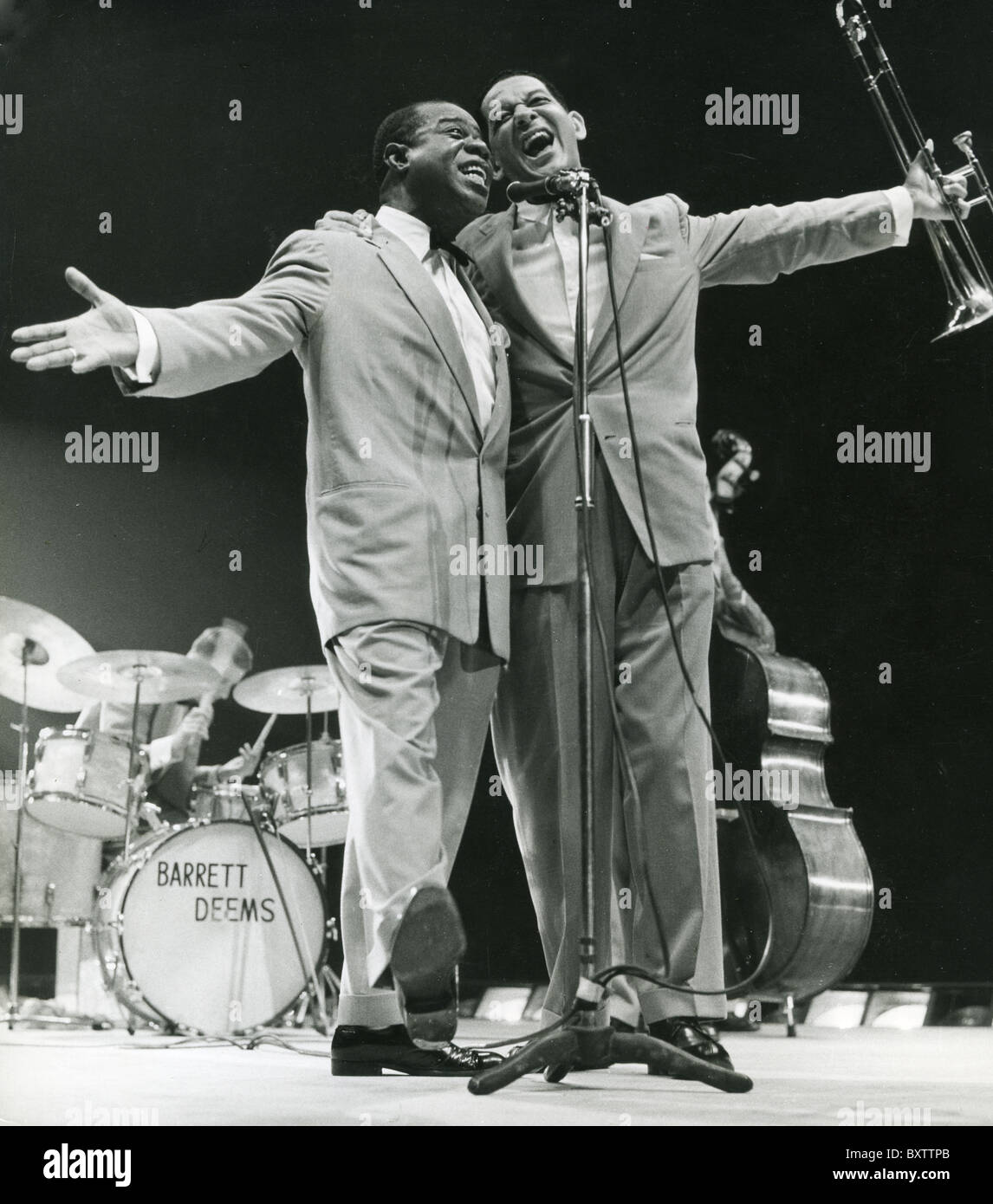 LOUIS ARMSTRONG (1901-1971) US jazz musician at left with Trummy Young ...