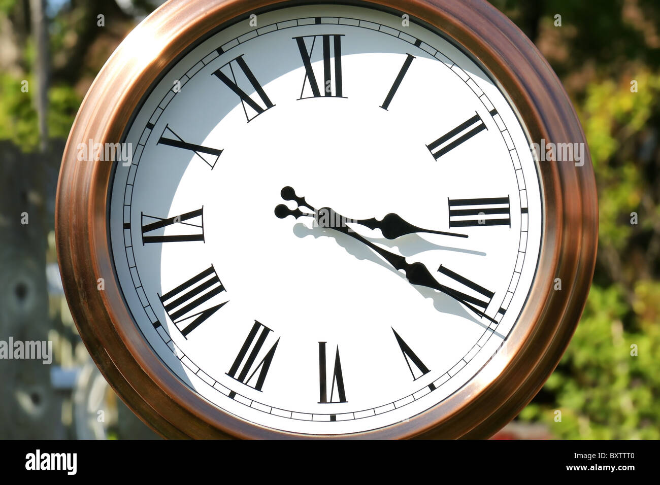 Close up of an outdoor copper surrounded clock face, placed in a ...