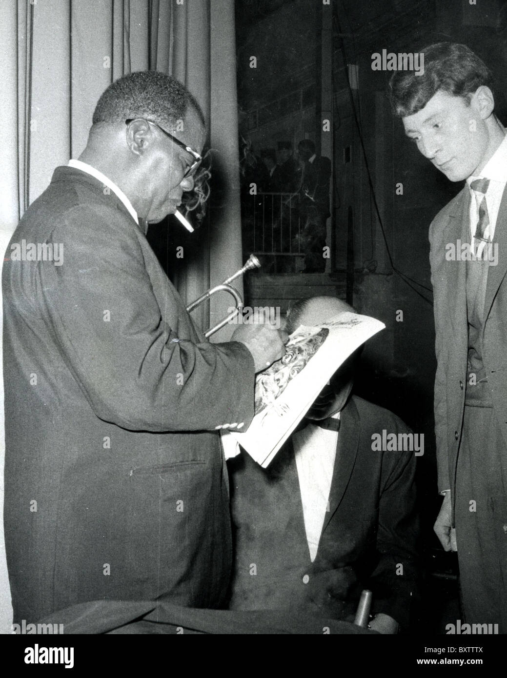 LOUIS ARMSTRONG (1901- US jazz musician signs his autograph Stock Photo ...