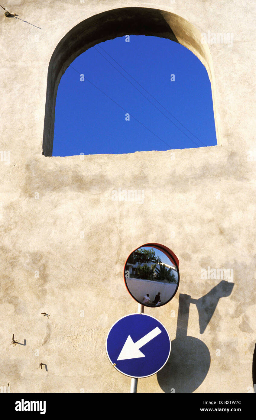 Street Sign And Mirror In Front Of Wall Stock Photo - Alamy