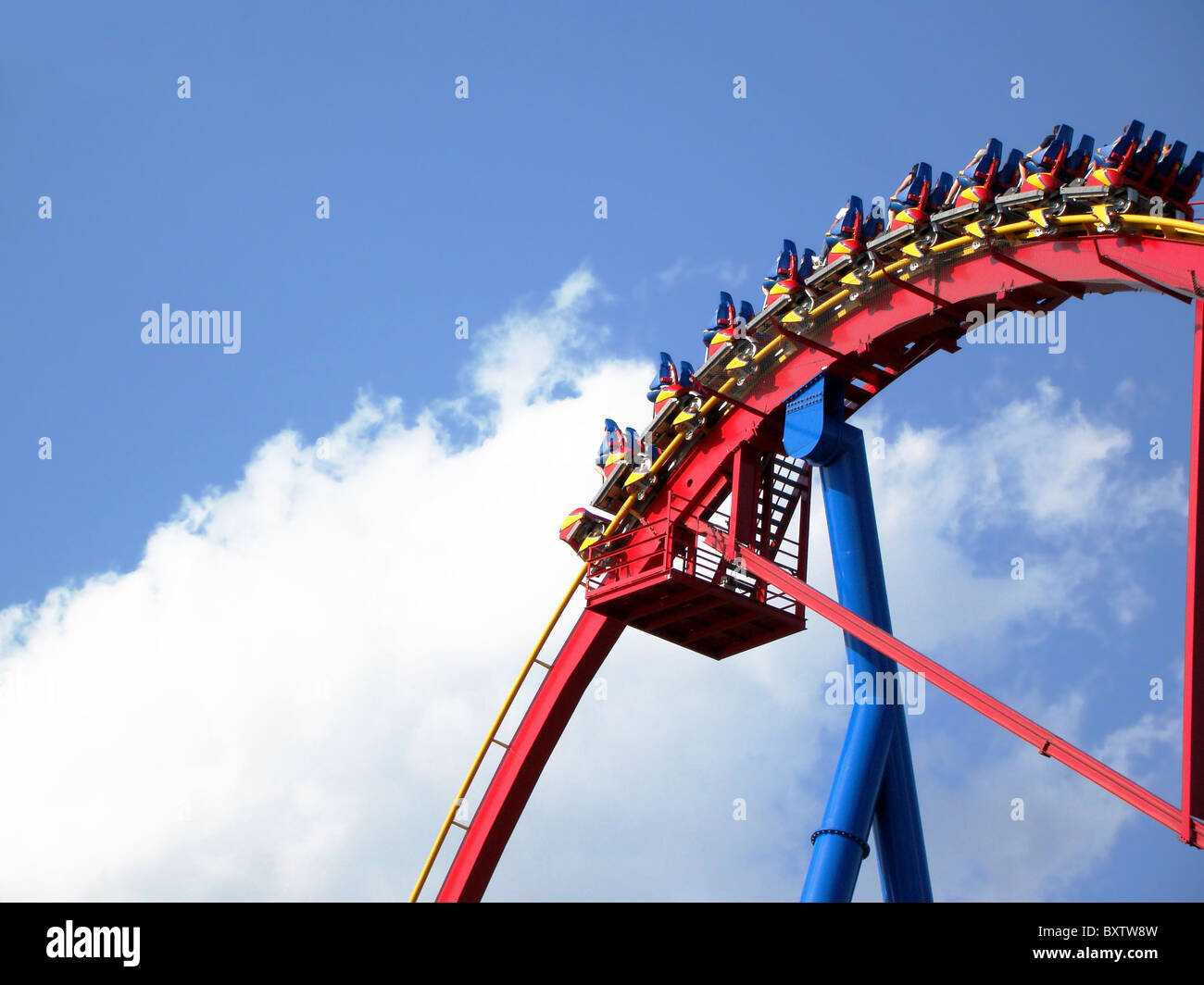 People going down on giant roller coaster ride, photo taken against ...