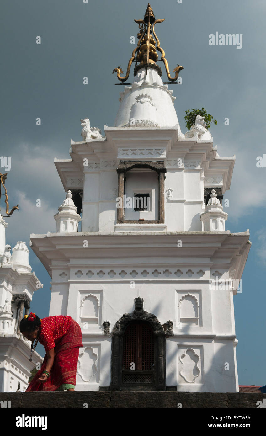 woman sweeping at the Hindu temple of Pashupatinath in Kathmandu, Nepal ...