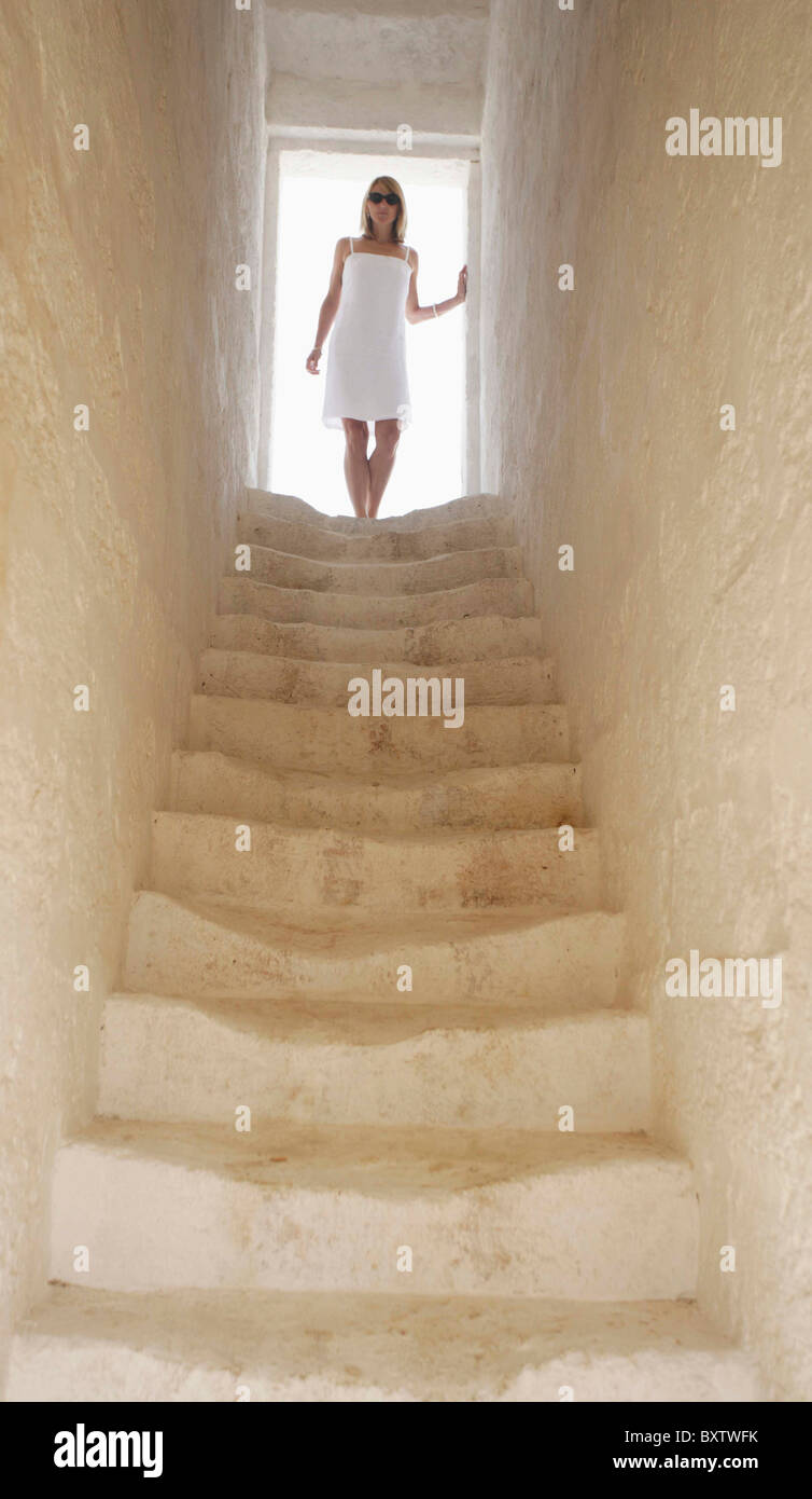 Woman standing on top of stairs hi-res stock photography and images - Alamy