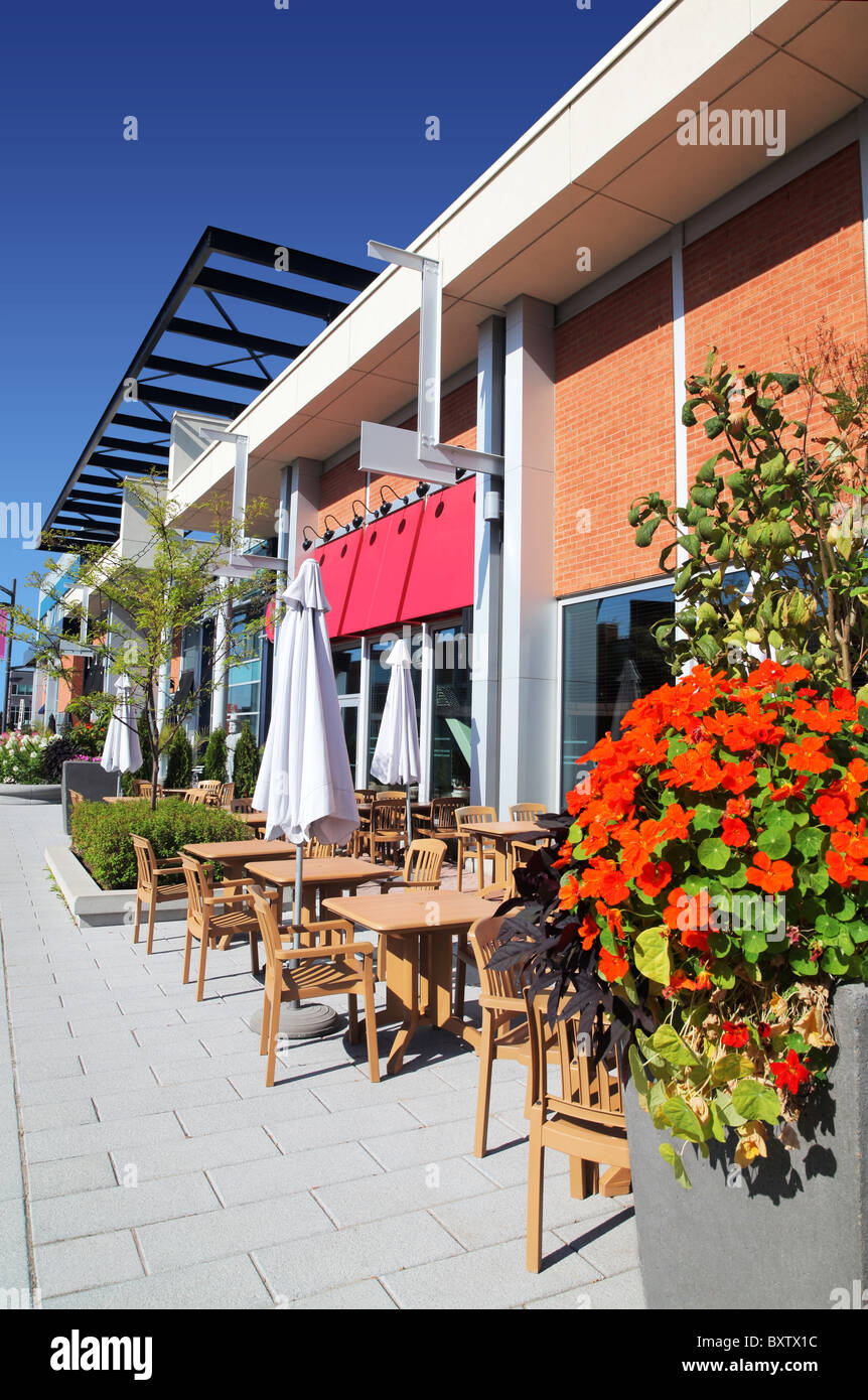 Vertical of an inviting modern sidewalk cafe restaurant on a bright ...