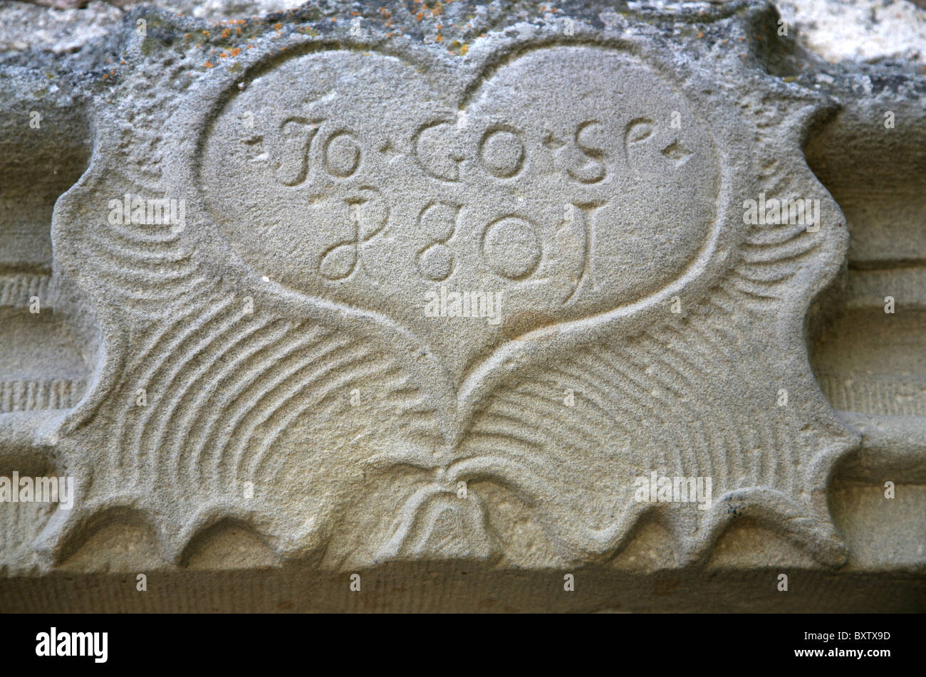 Antique sandstone engraving in a house portal Stock Photo - Alamy