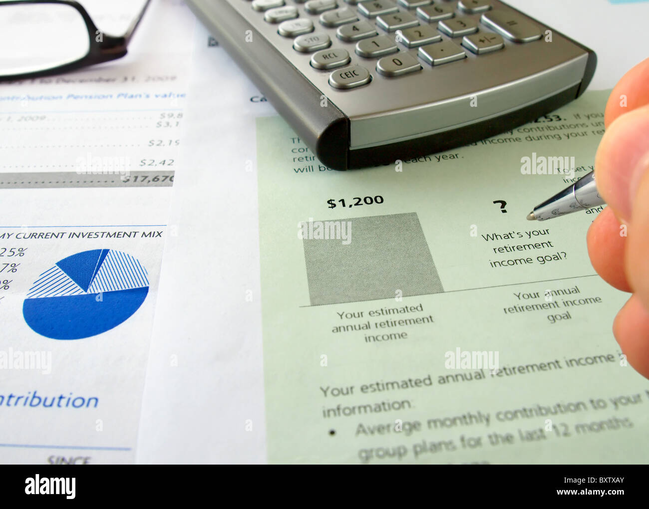 Male hand with pen on the financial document with calculator and ...