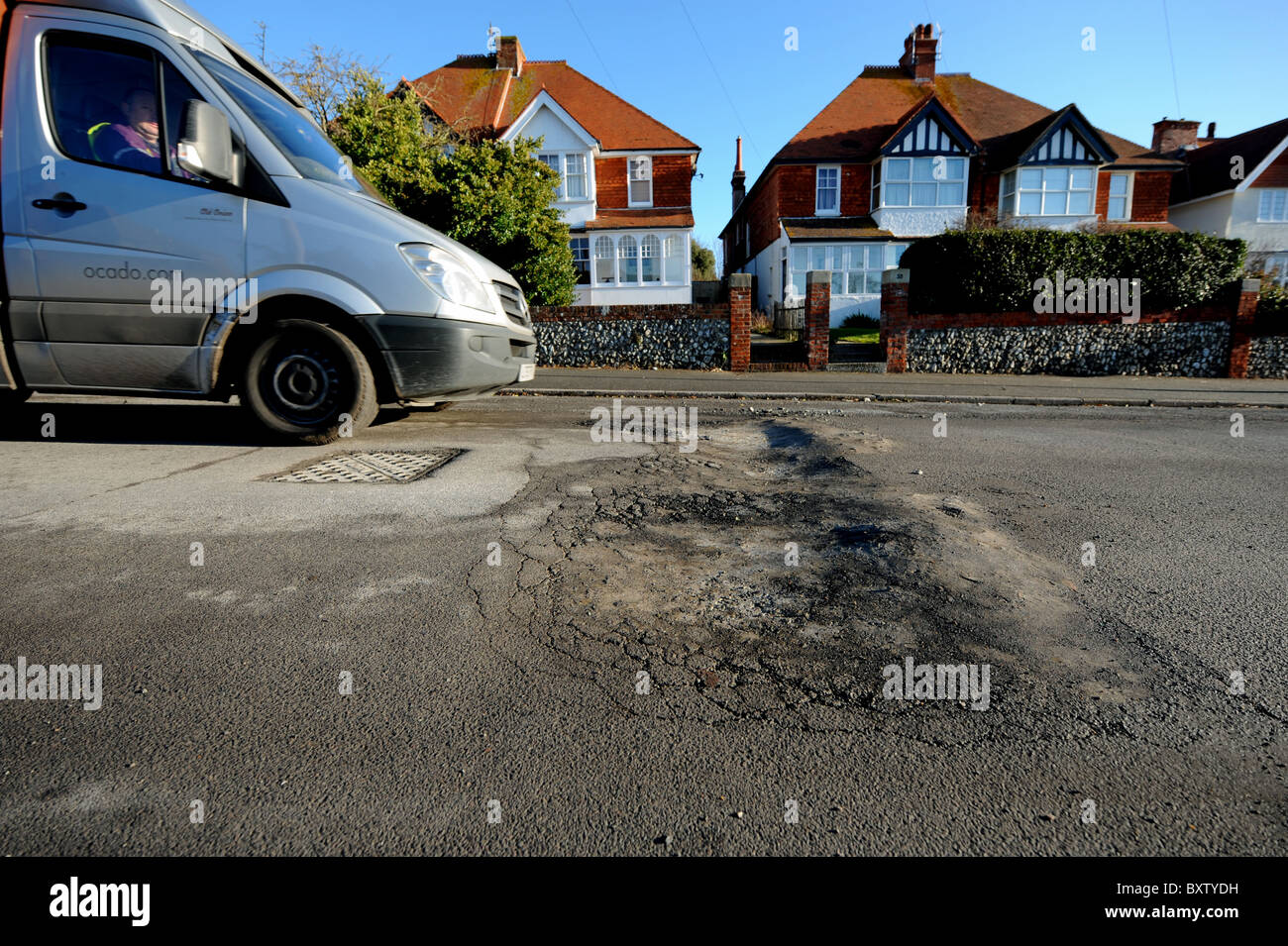 UK - Potholes in a road in Seaford East Sussex . The cold winter ...