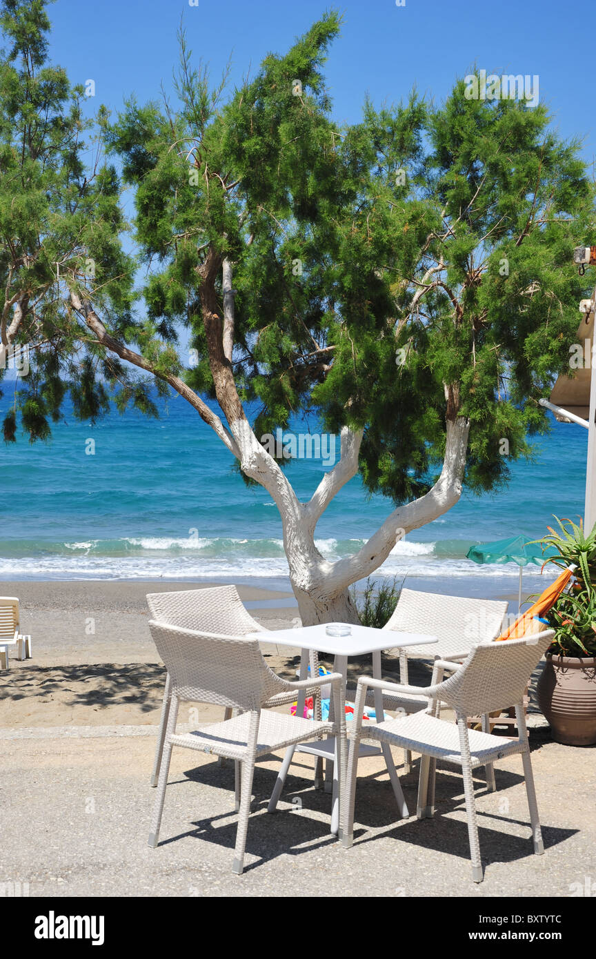 Restaurant white table and chairs overlooking the beach and sea Stock ...