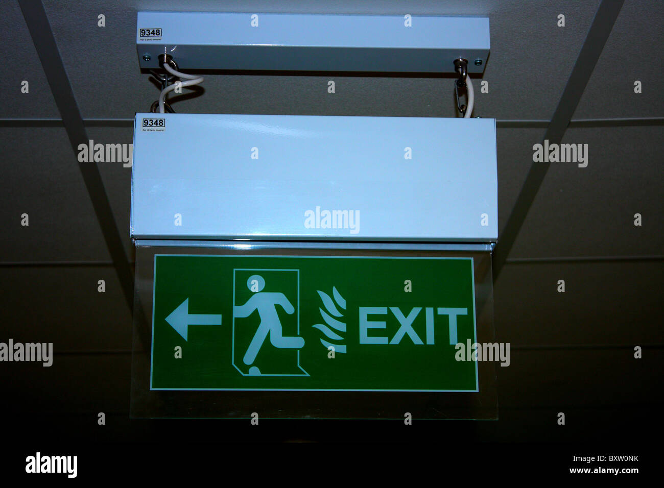 A green ceiling exit to stairway sign, showing where the exit is to ...