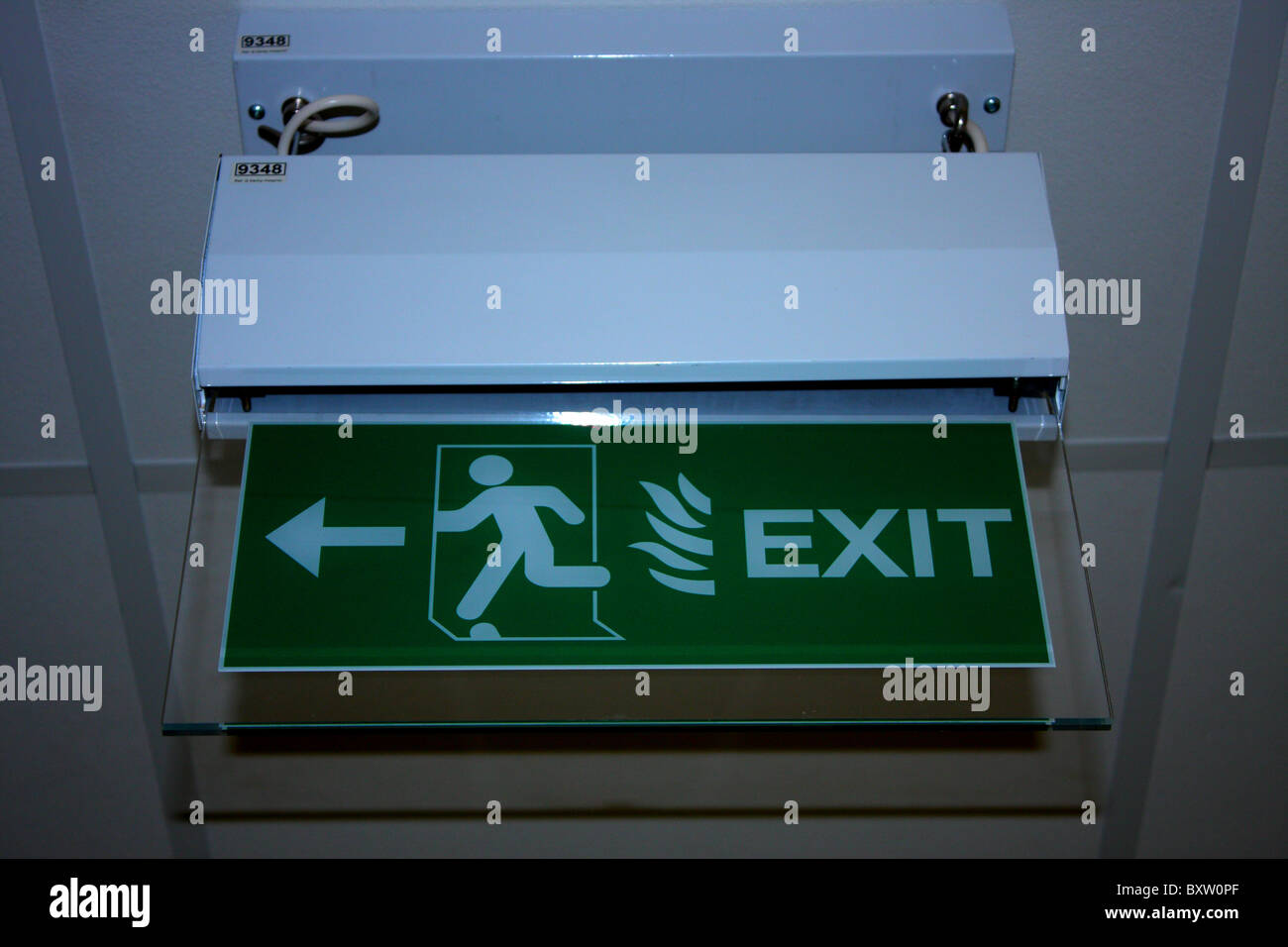 A green ceiling exit to stairway sign, showing where the exit is to ...