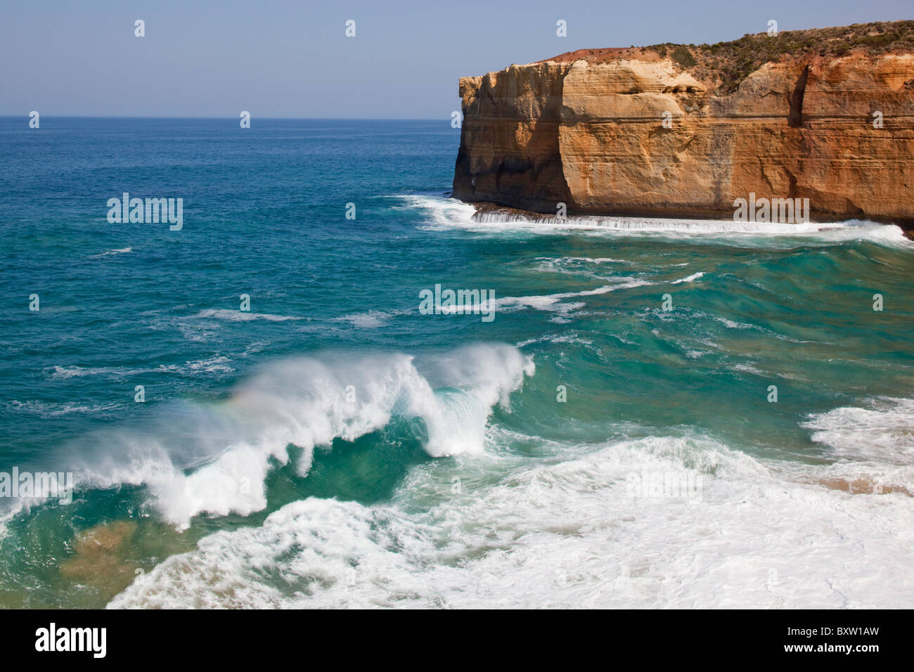 Australia, Victoria, Port Campbell, Waves crashing into steep cliffs ...