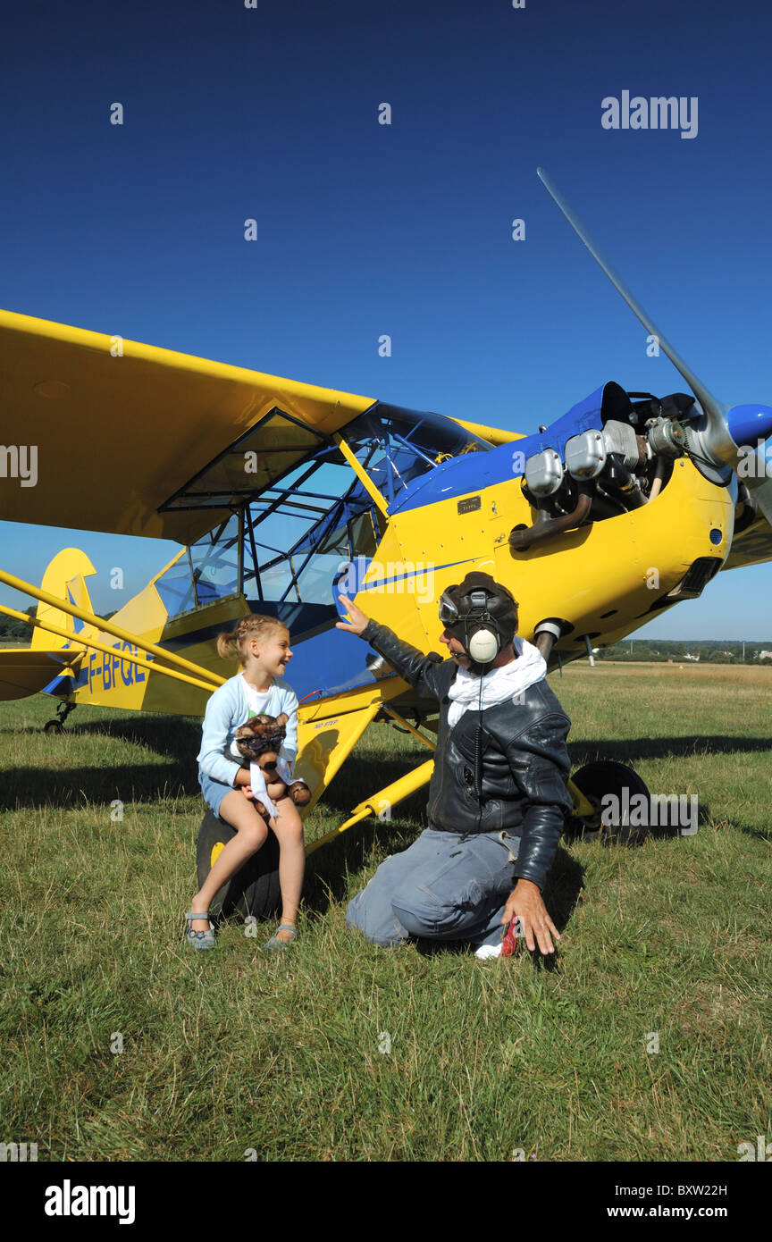 A father private pilot with his young daughter around a famous Piper J ...
