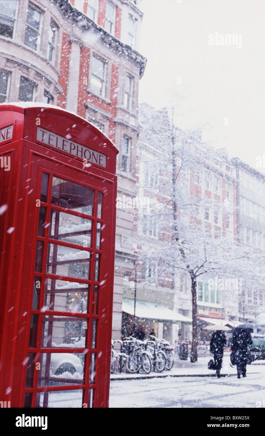 Snow Falling On Red Telephone Box In Marketplace Stock Photo - Alamy